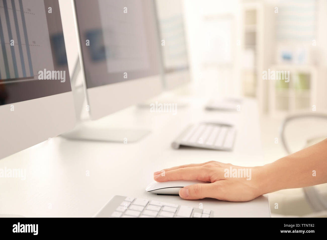 Female hand holding mouse while working on computer Stock Photo - Alamy