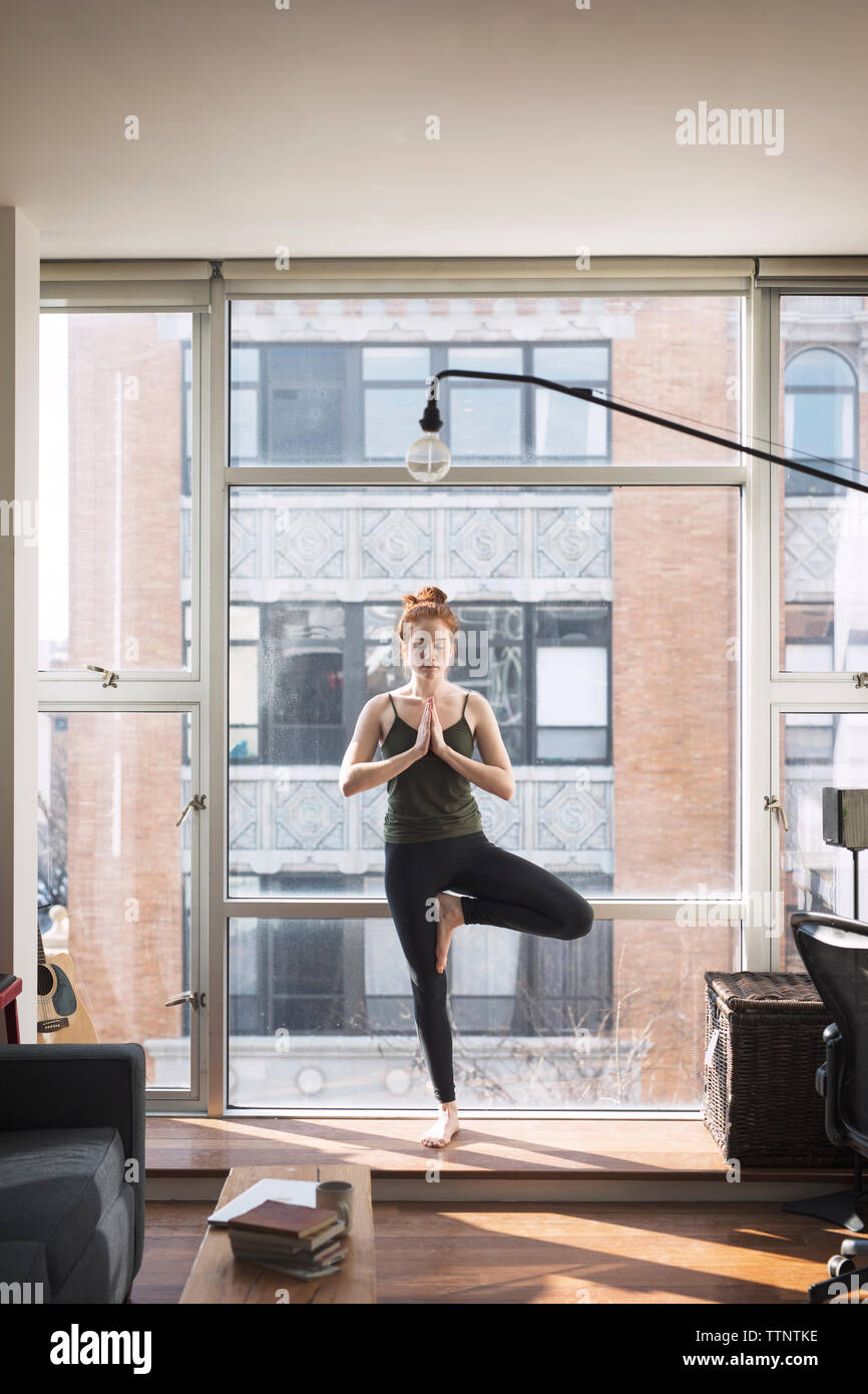 Woman stretching arms standing window hi-res stock photography and ...