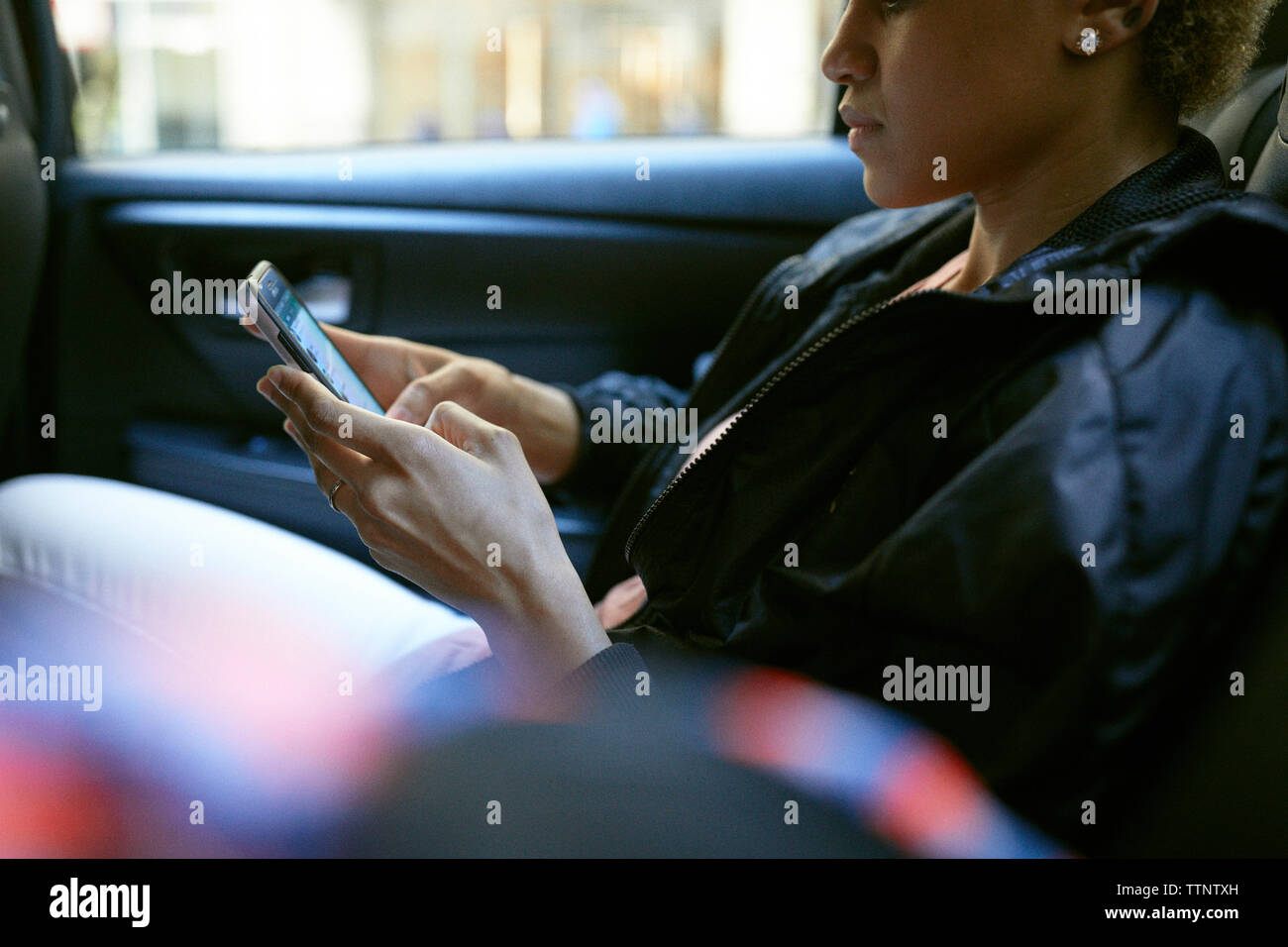 Young woman in back of taxi hi-res stock photography and images - Alamy