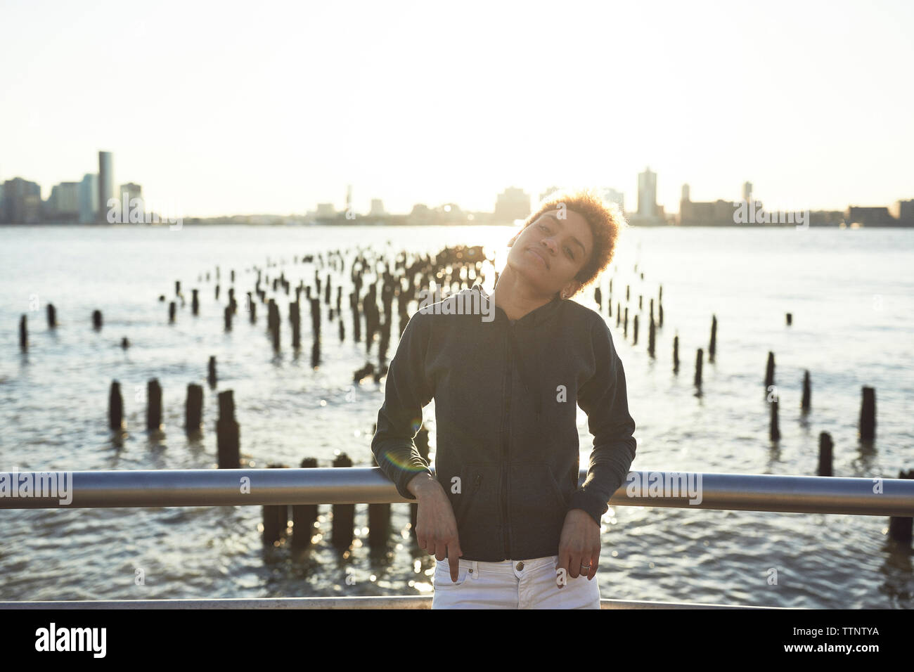 Woman leaning on railing hi-res stock photography and images - Alamy