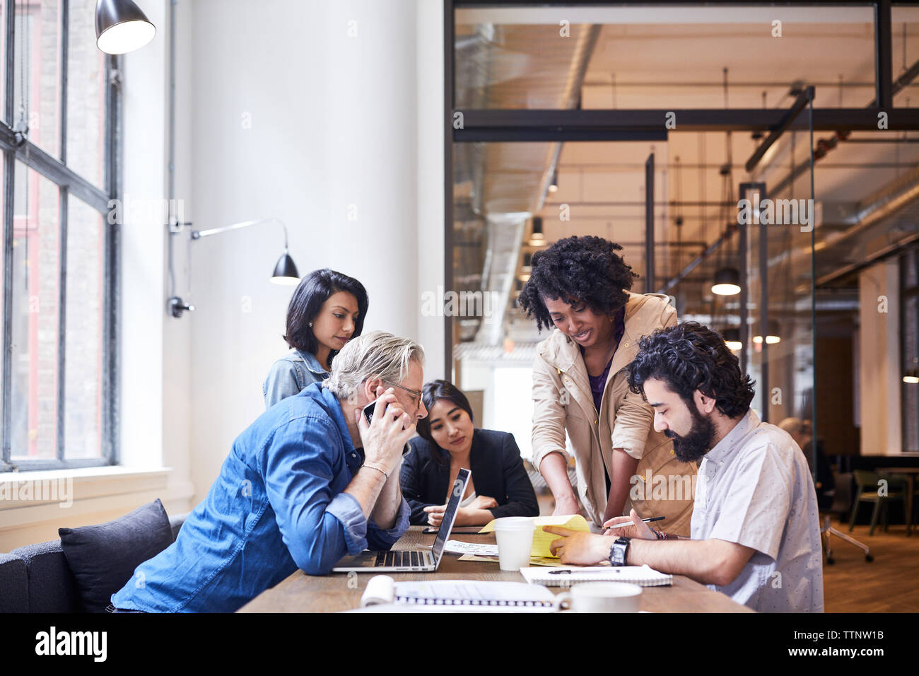 Business people discussing over documents hi-res stock photography and ...