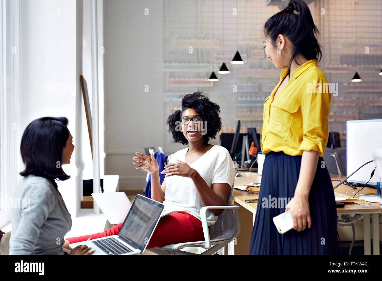 African asian female colleagues talking hi-res stock photography and ...