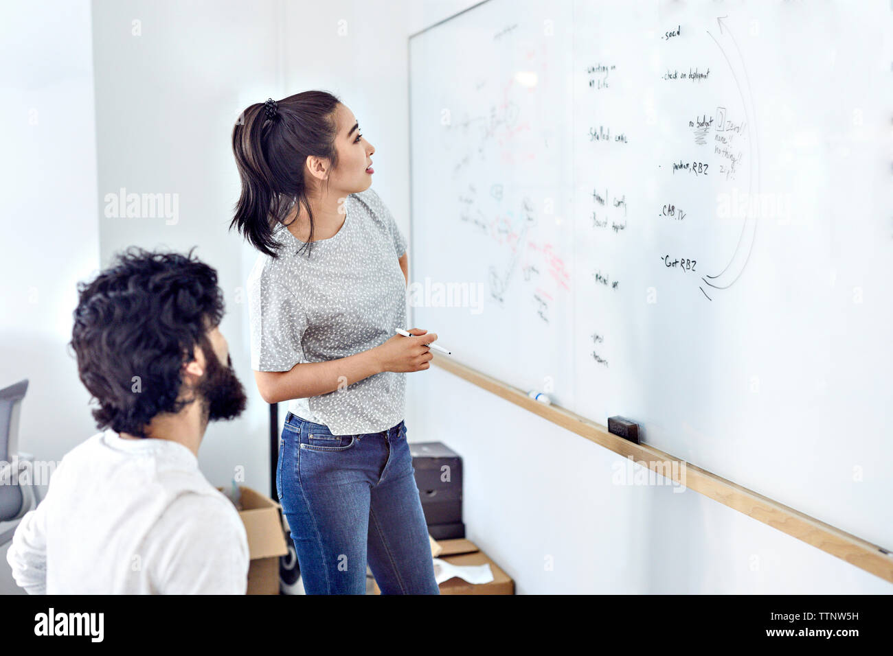 business people examining data on whiteboard in creative office Stock ...