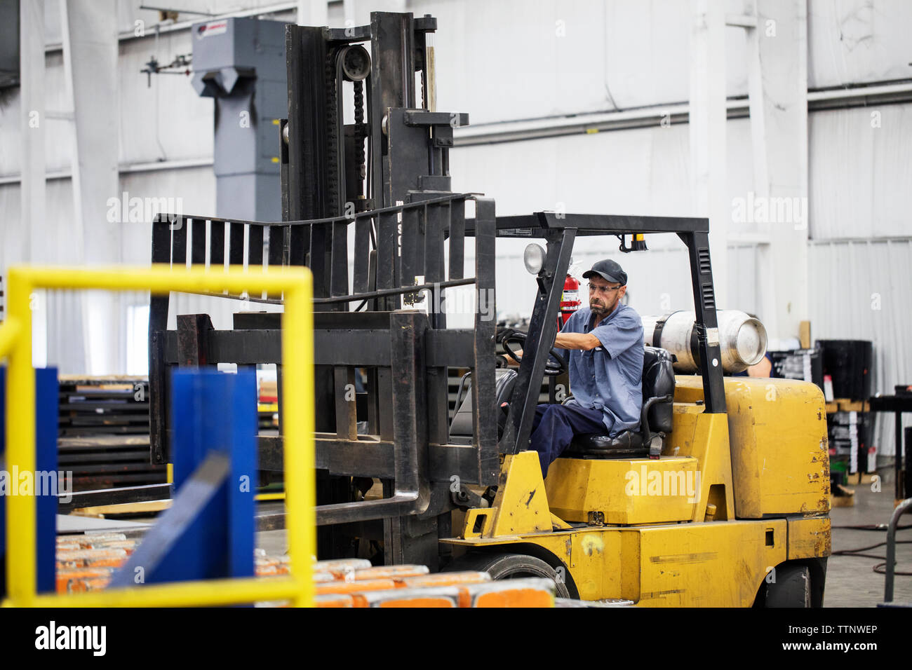 worker driving forklift in Steel industry Factory Stock Photo - Alamy