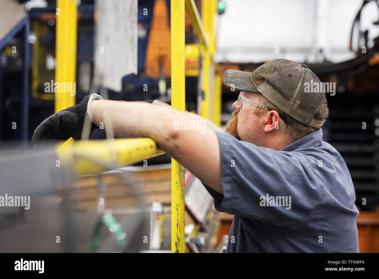 Side view of worker in Steel industry Factory Stock Photo - Alamy