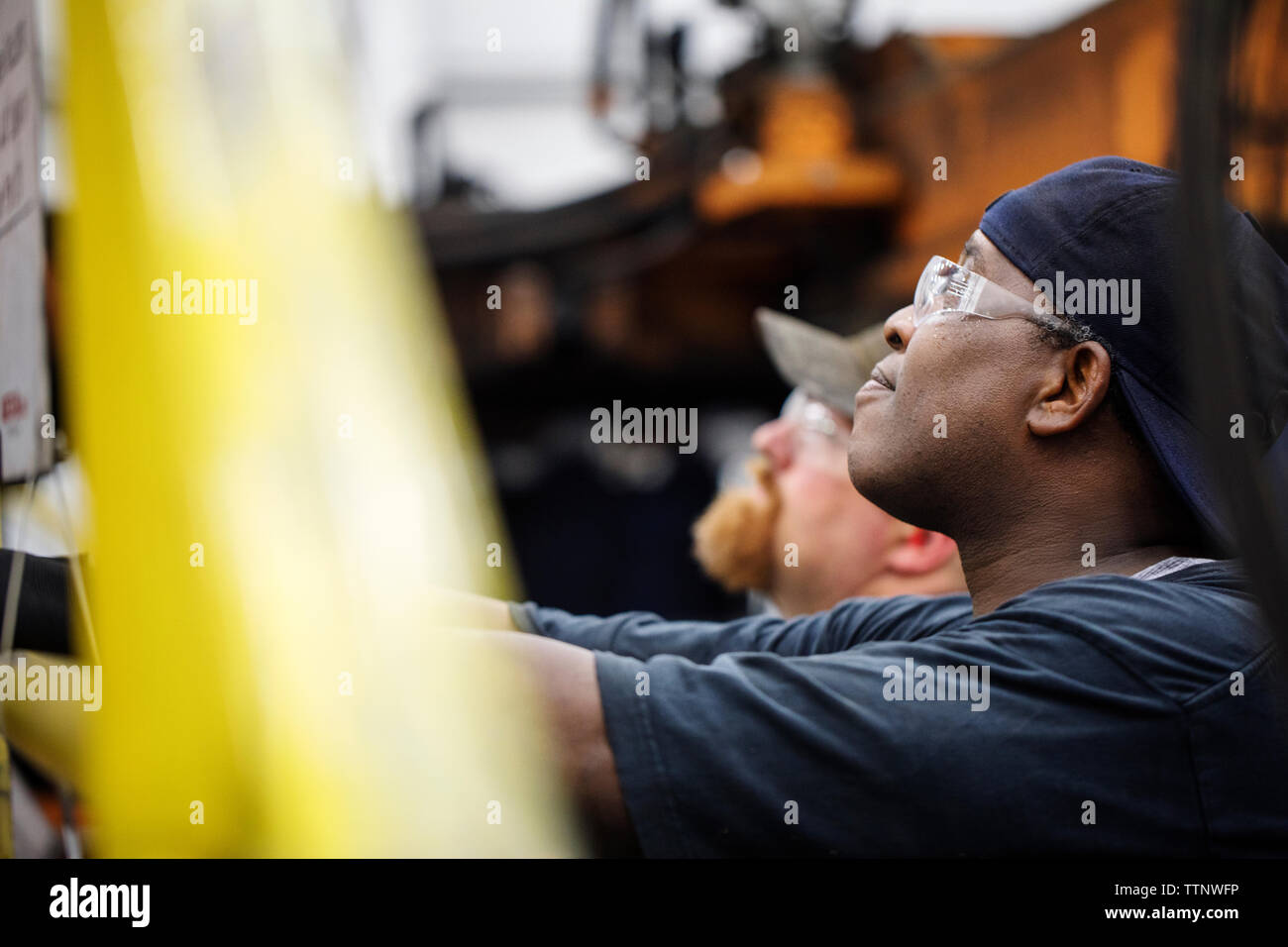 Side view of workers working in Steel industry Factory Stock Photo - Alamy