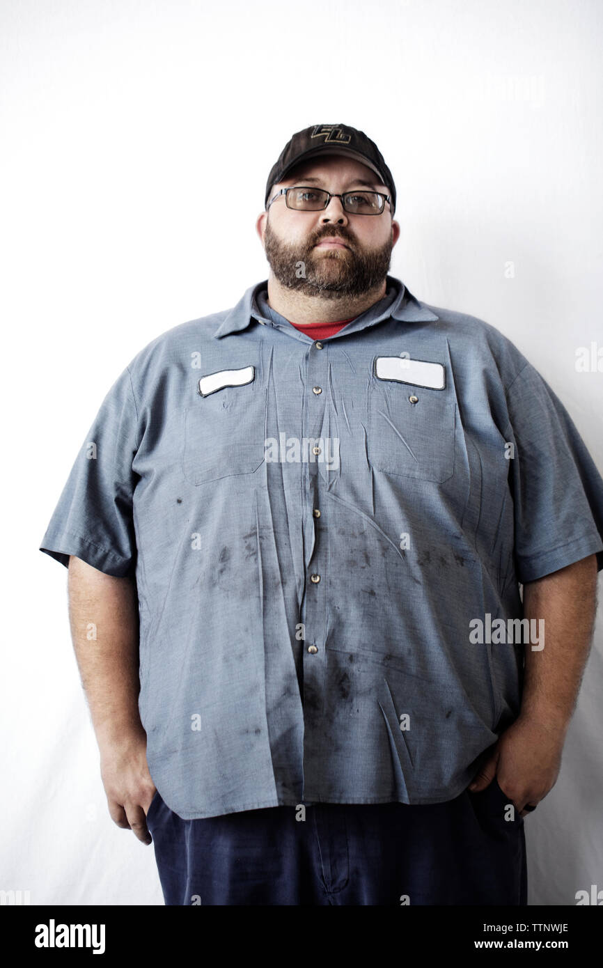 Portrait of worker standing against white background Stock Photo - Alamy