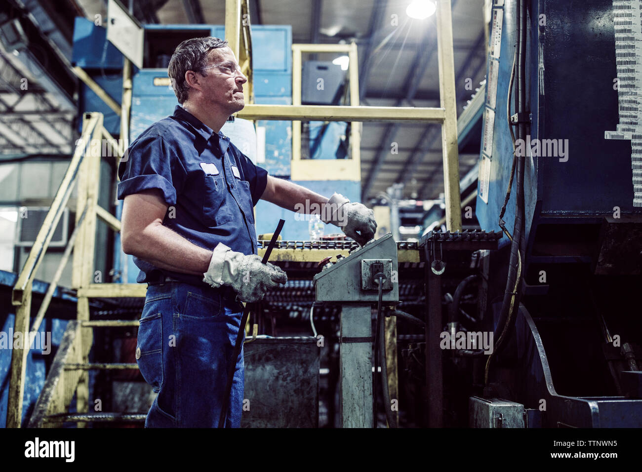 worker using control machine while working in steel industry Stock ...