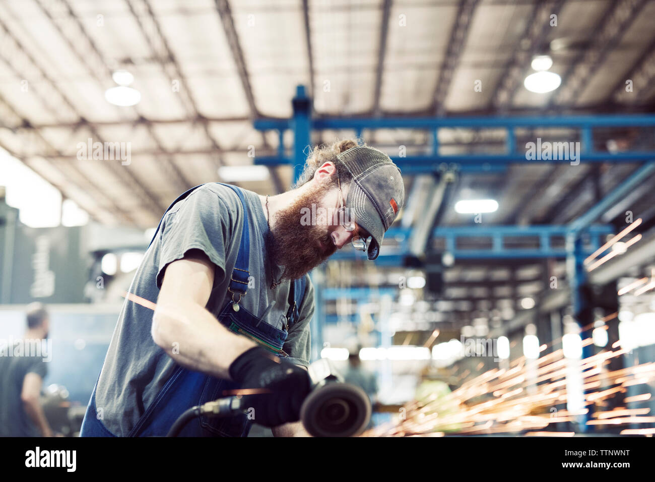 worker using welding machine in steel factory Stock Photo - Alamy