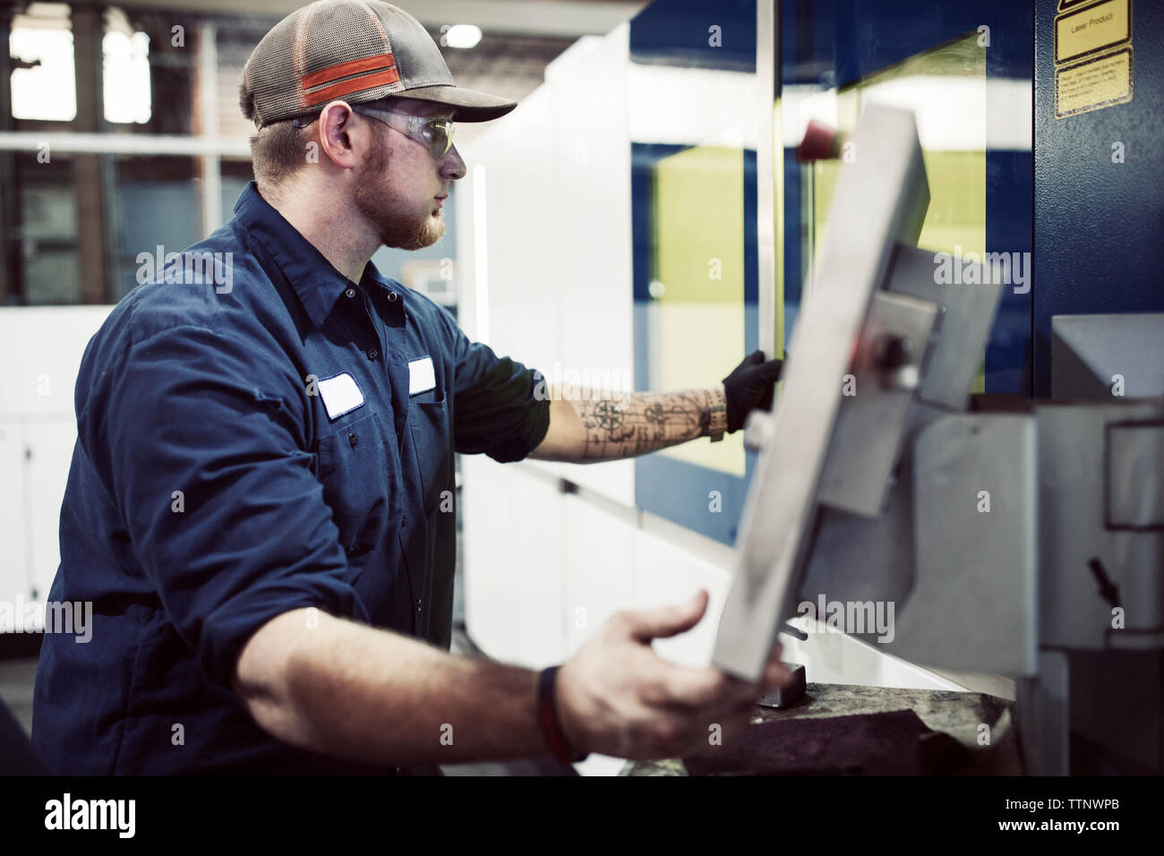 Manual worker using desktop computer in steel factory Stock Photo - Alamy