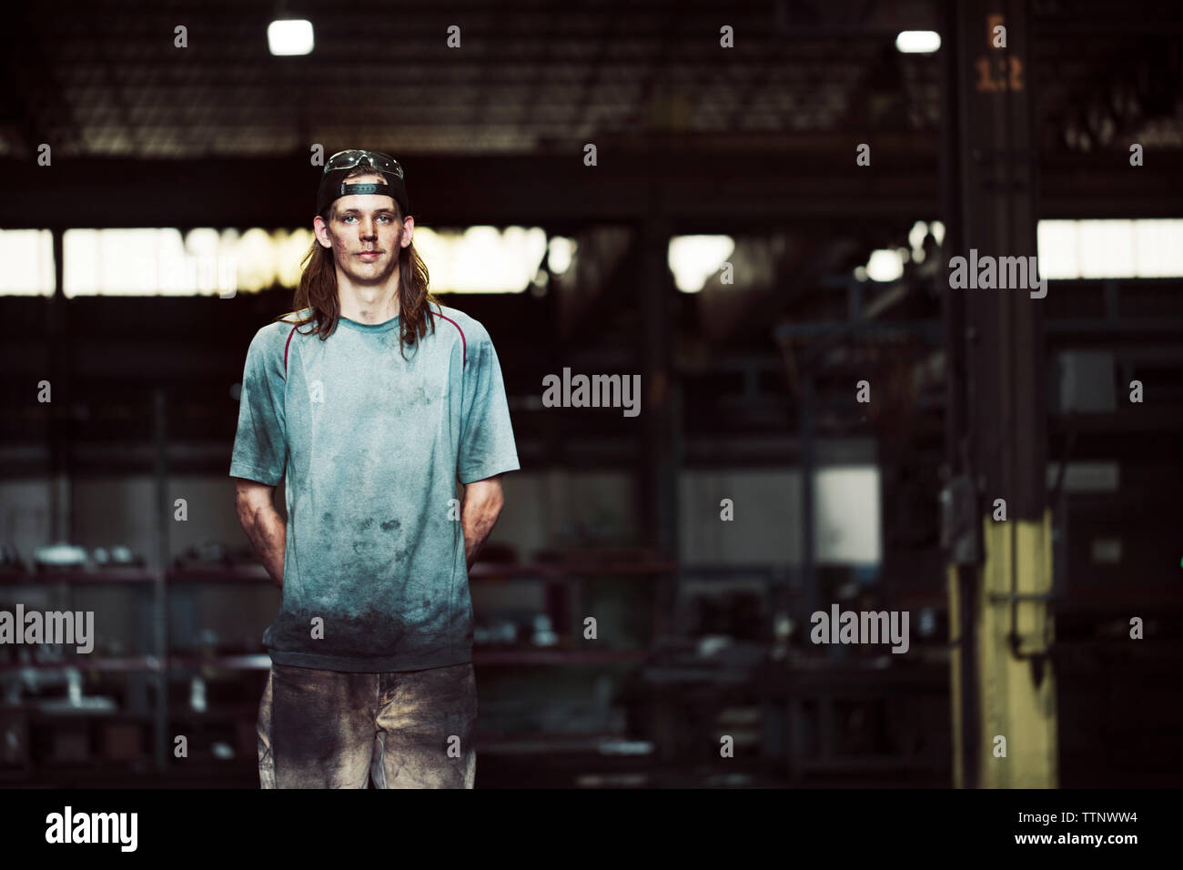 Portrait of messy worker standing in steel industry Stock Photo - Alamy