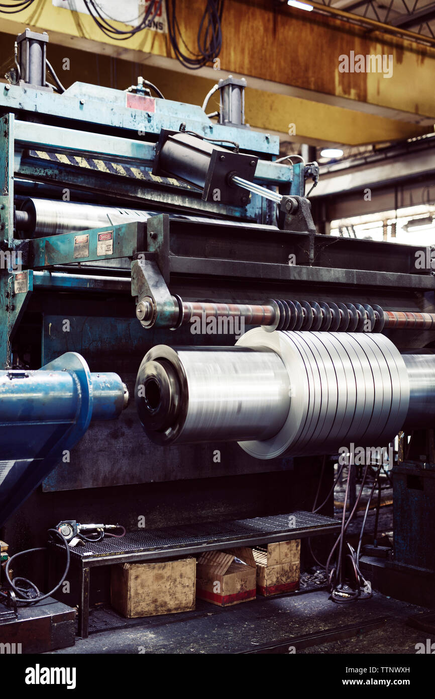 Metal sheets spinning on machine at industry Stock Photo - Alamy