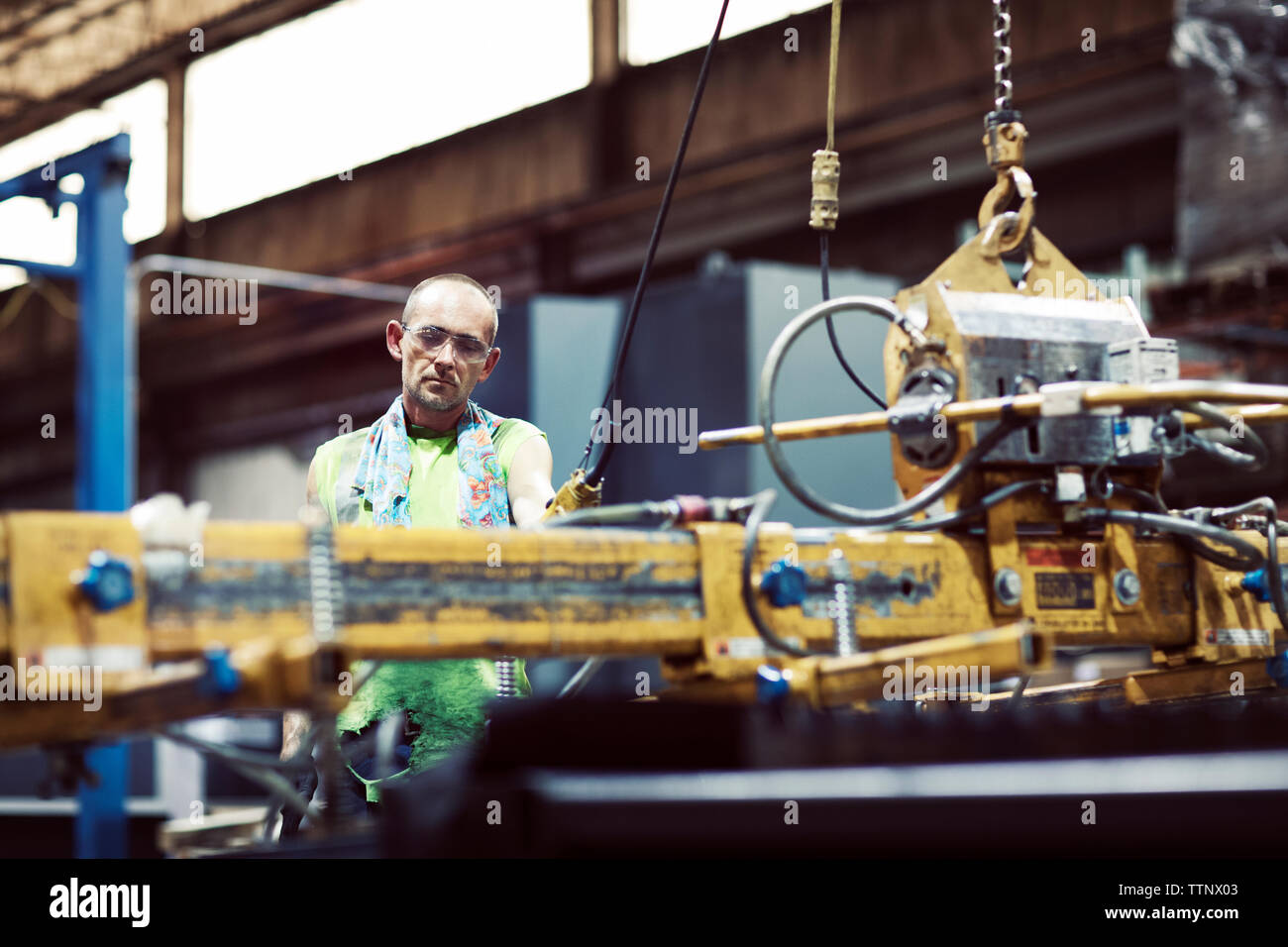 Man working on machinery in steel industry Stock Photo - Alamy