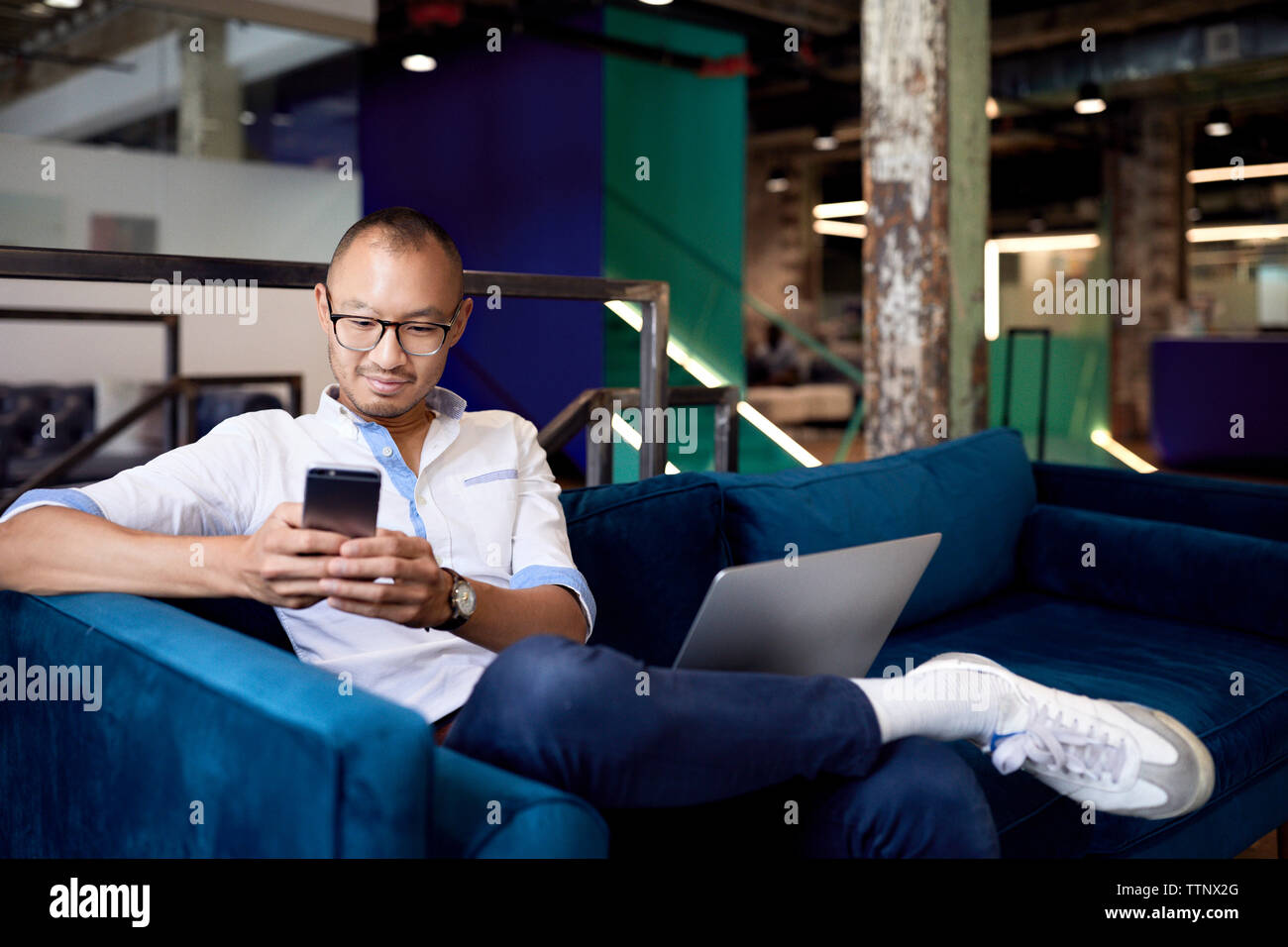 Person sitting on sofa mobile phone hi-res stock photography and images ...