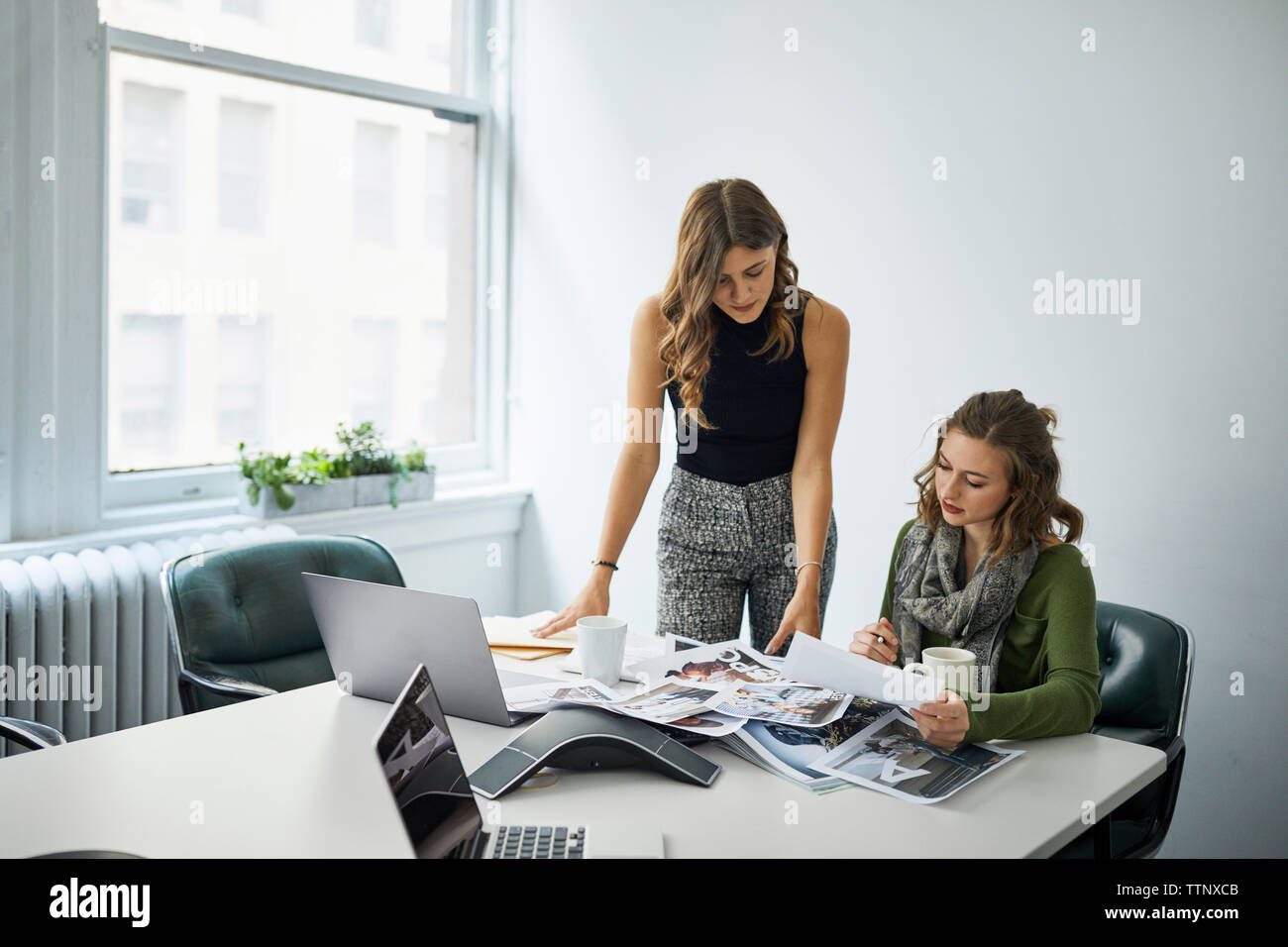 Two young people looking documents hi-res stock photography and images ...