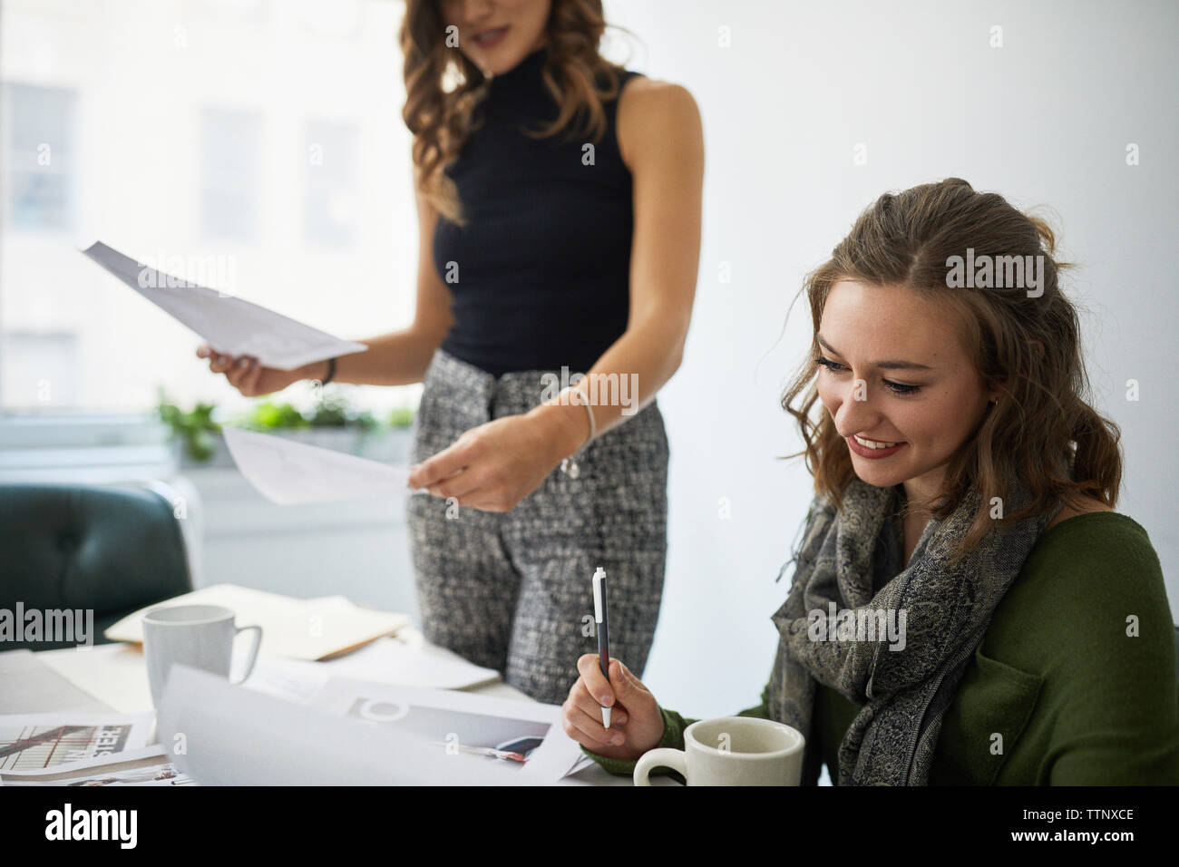Two young people looking documents hi-res stock photography and images ...