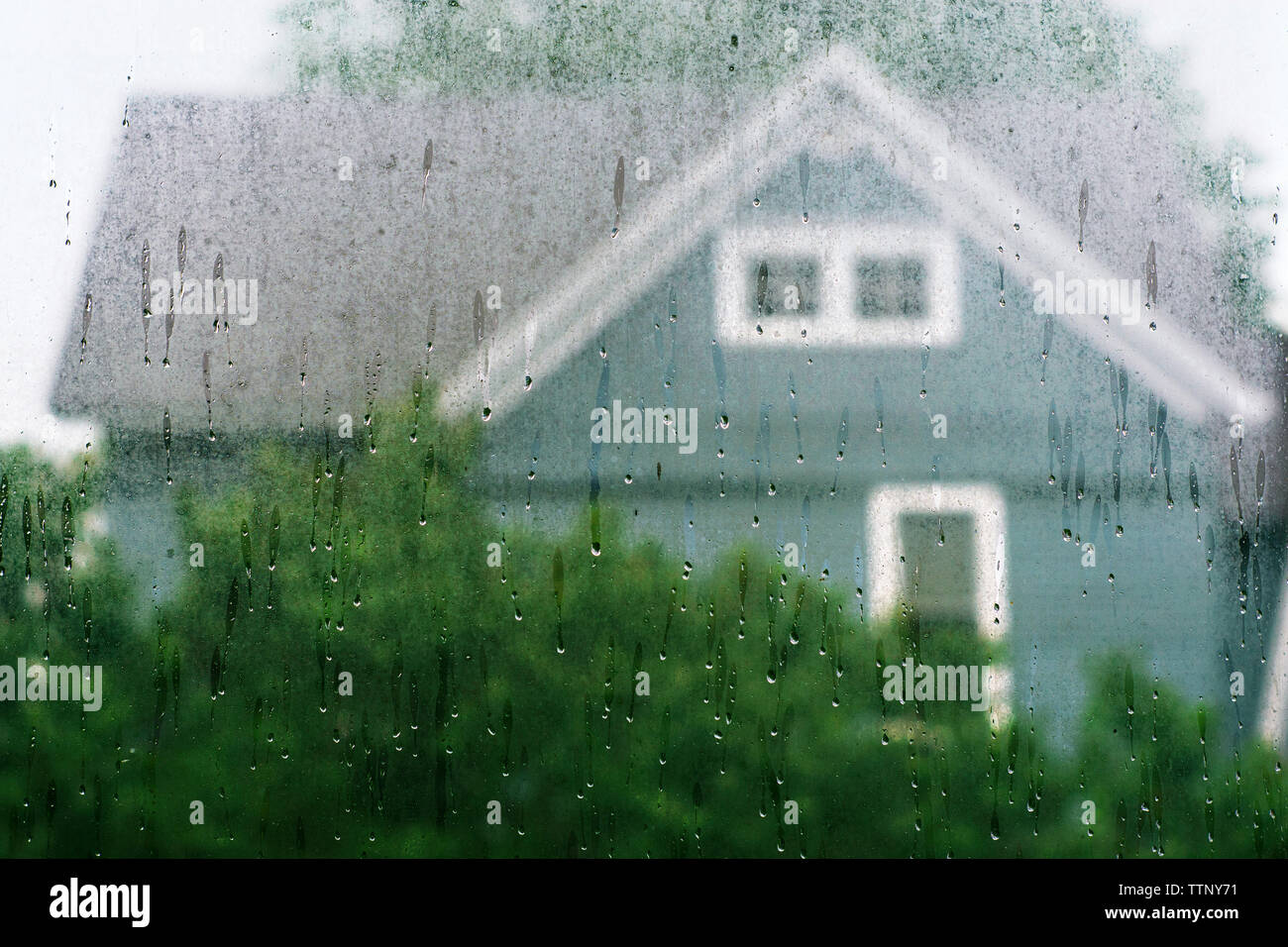 House seen through wet glass window Stock Photo - Alamy