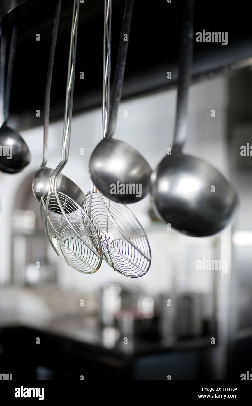 Spoons hanging in kitchen Stock Photo - Alamy