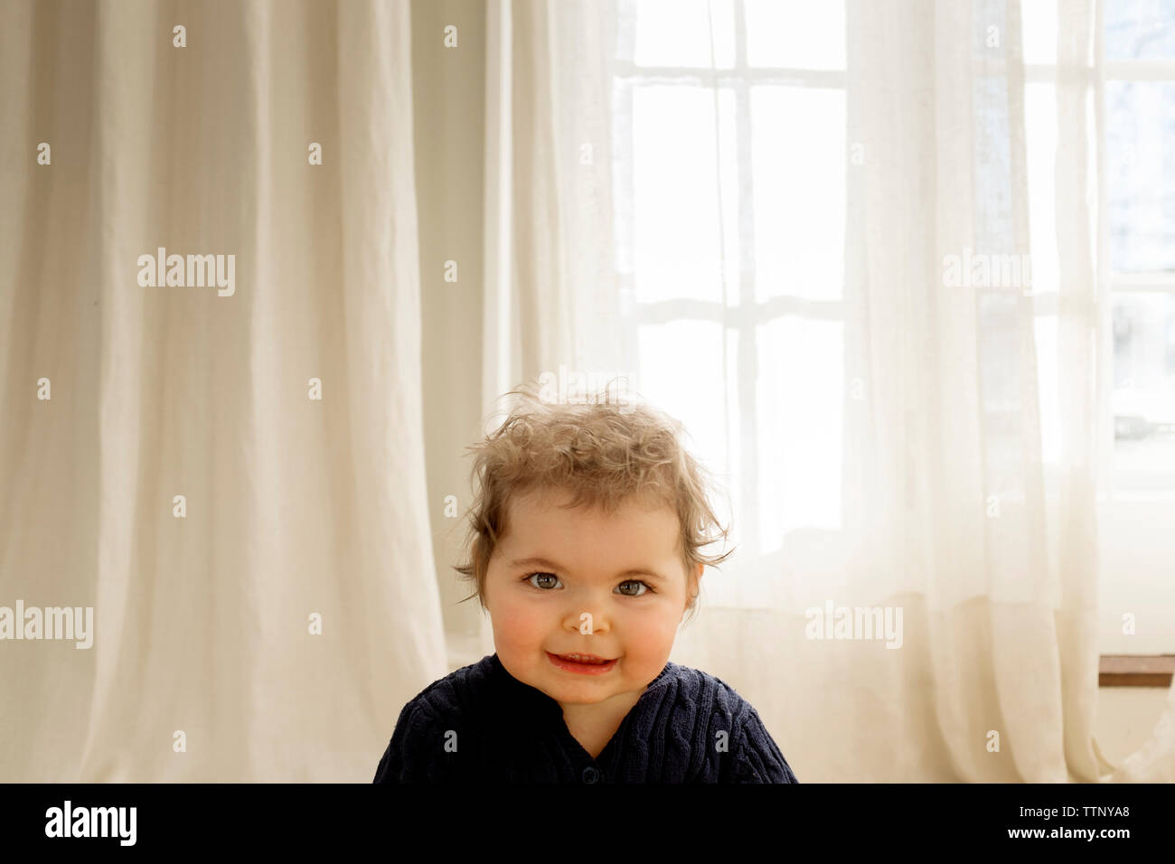 Portrait of cute baby girl at home Stock Photo - Alamy