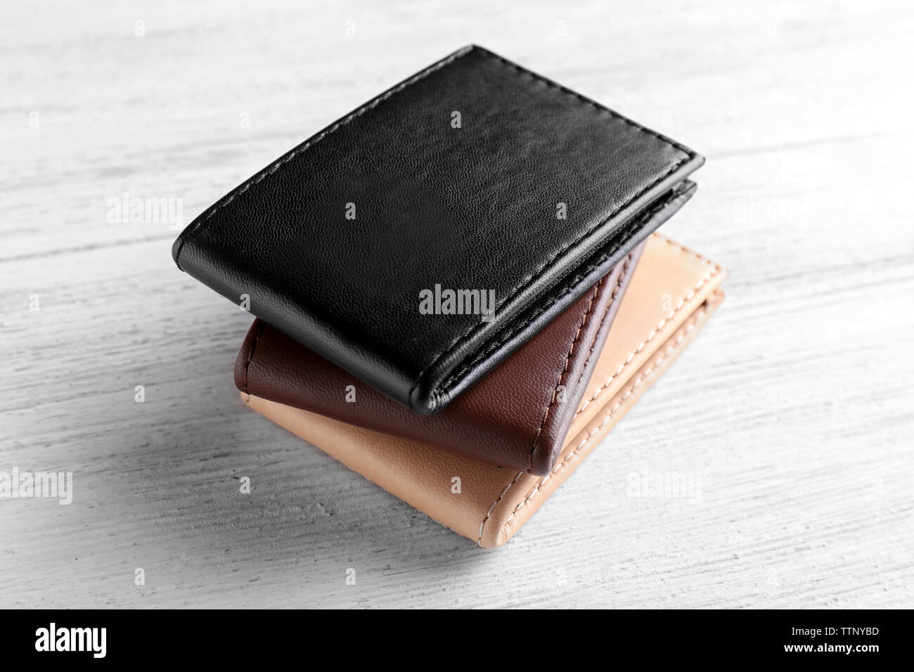 Leather wallets on wooden background Stock Photo - Alamy