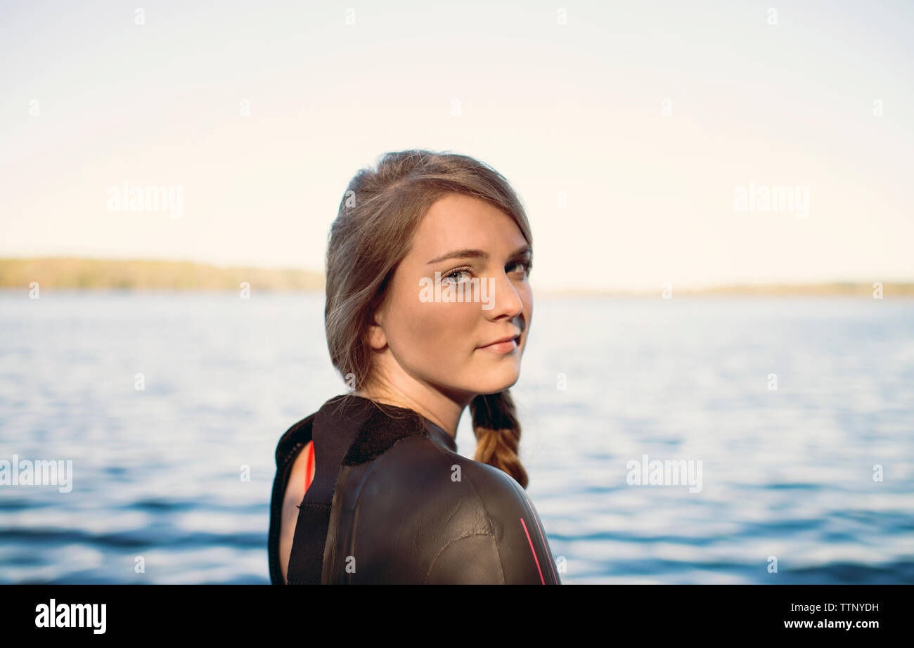 Side view portrait of confident female swimmer at lakeshore Stock Photo ...