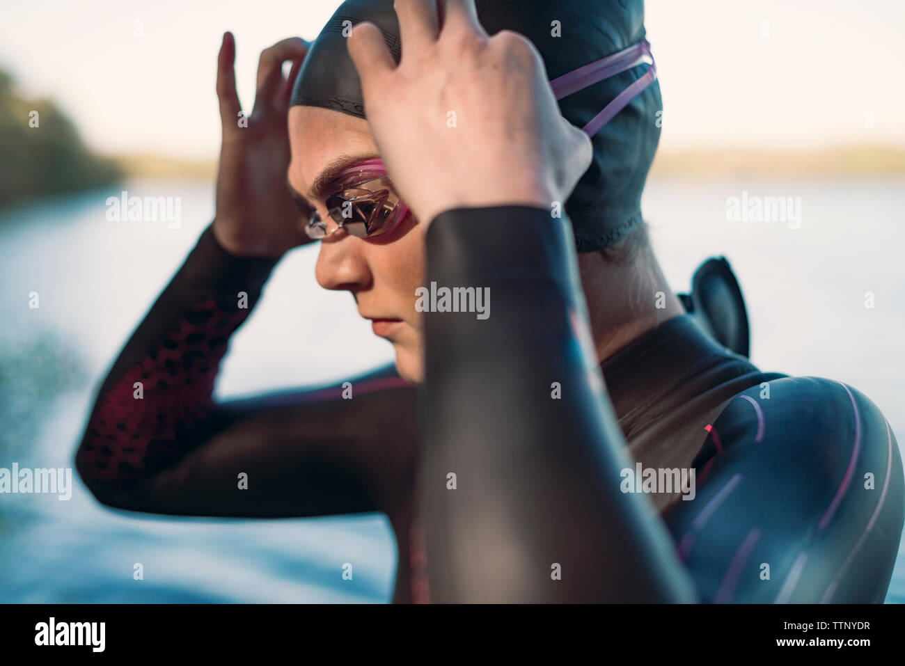 Female swimmer wearing swimming goggles at lakeshore Stock Photo - Alamy