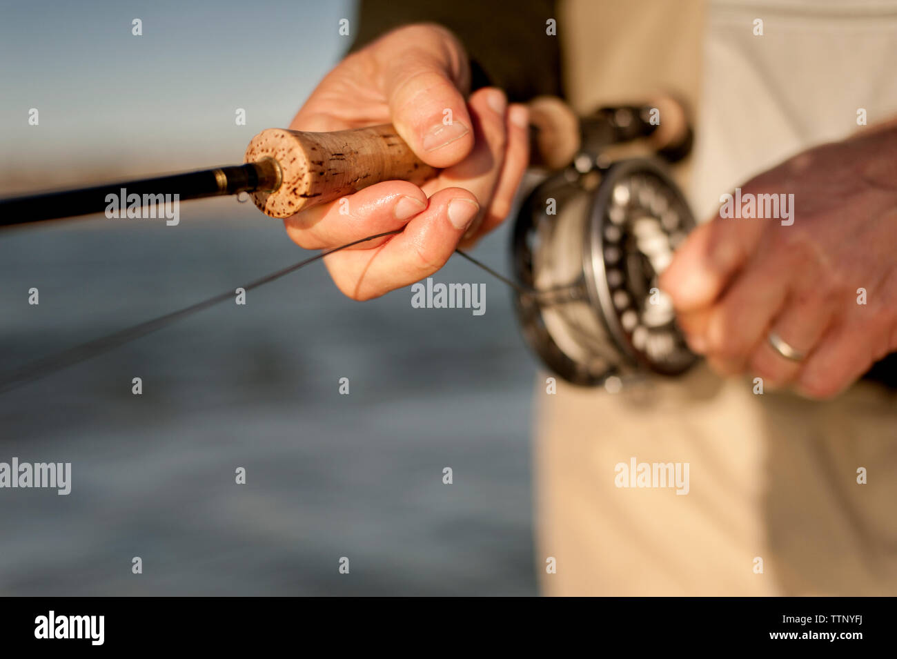 Man holding fishing rod hi-res stock photography and images - Alamy