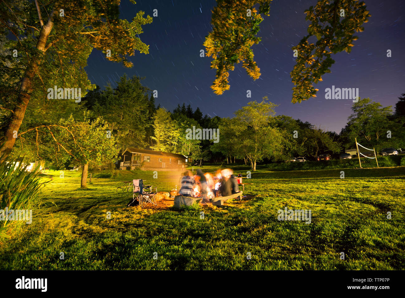Friends camping at backyard during night Stock Photo - Alamy