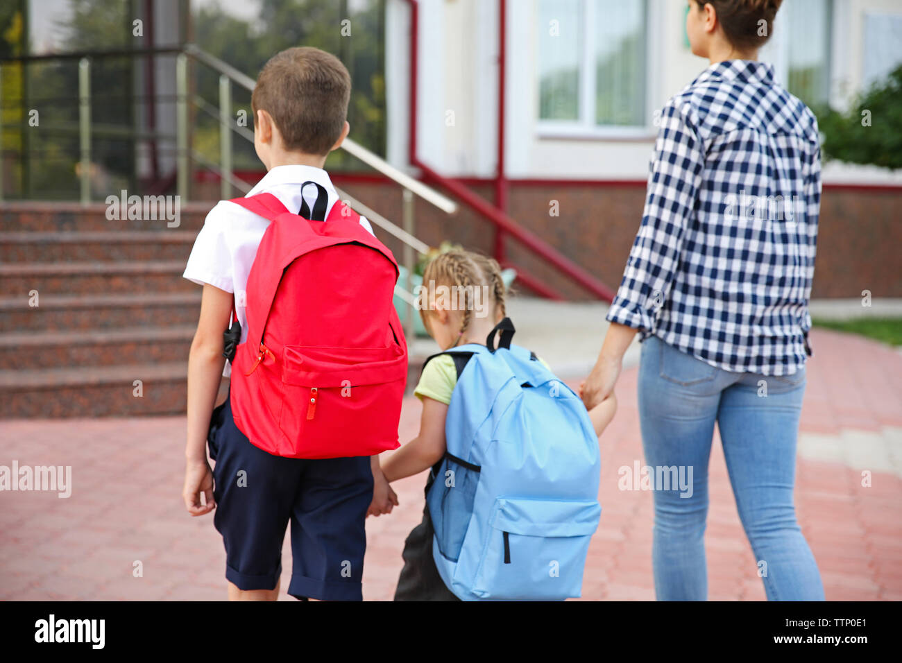 Mother taking children to school Stock Photo - Alamy