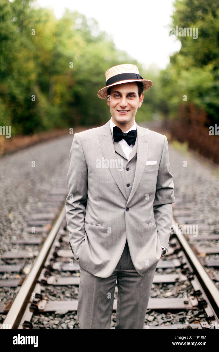 Portrait of man standing on railroad tracks Stock Photo - Alamy