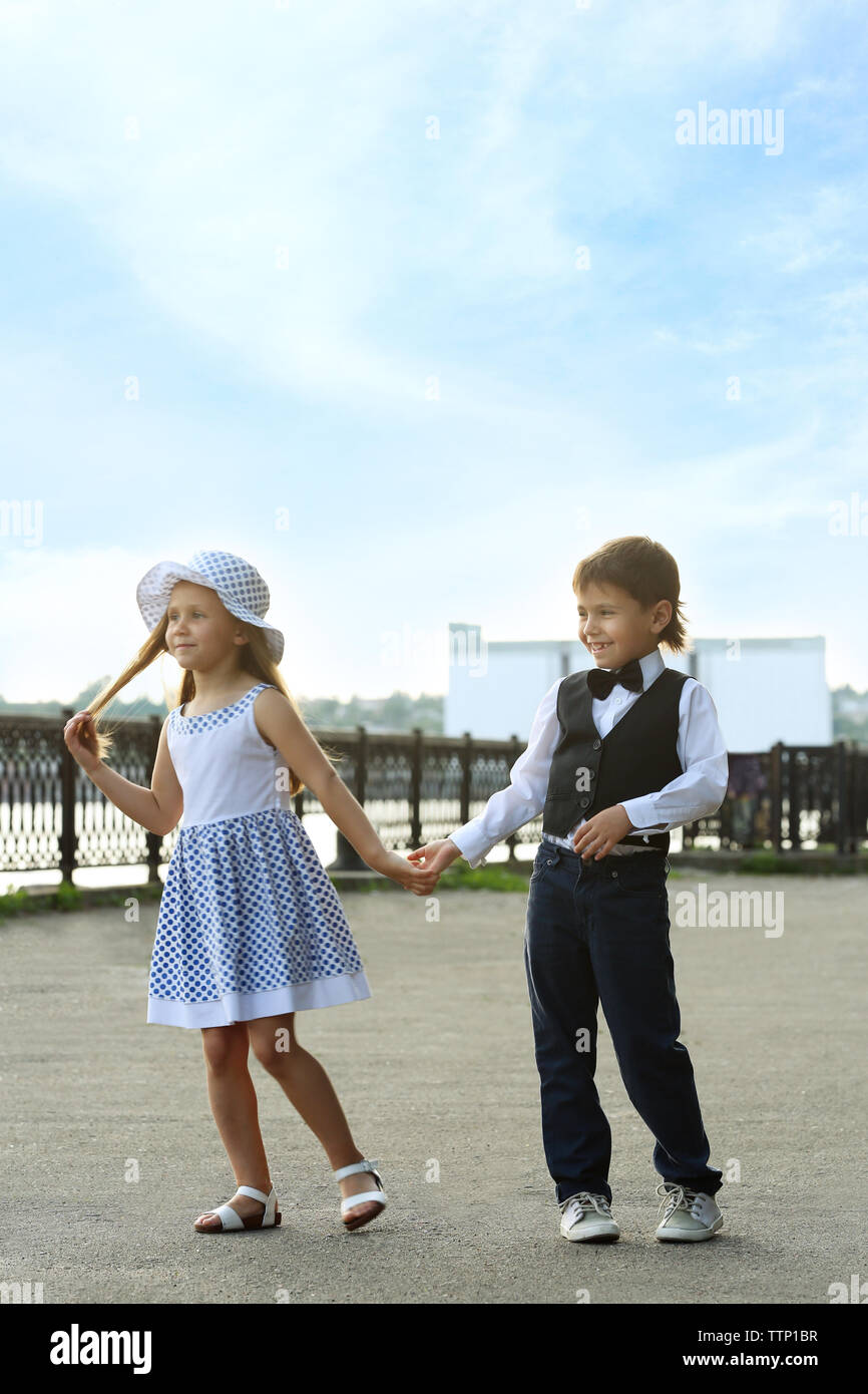 Two kids playing on river bank Stock Photo - Alamy