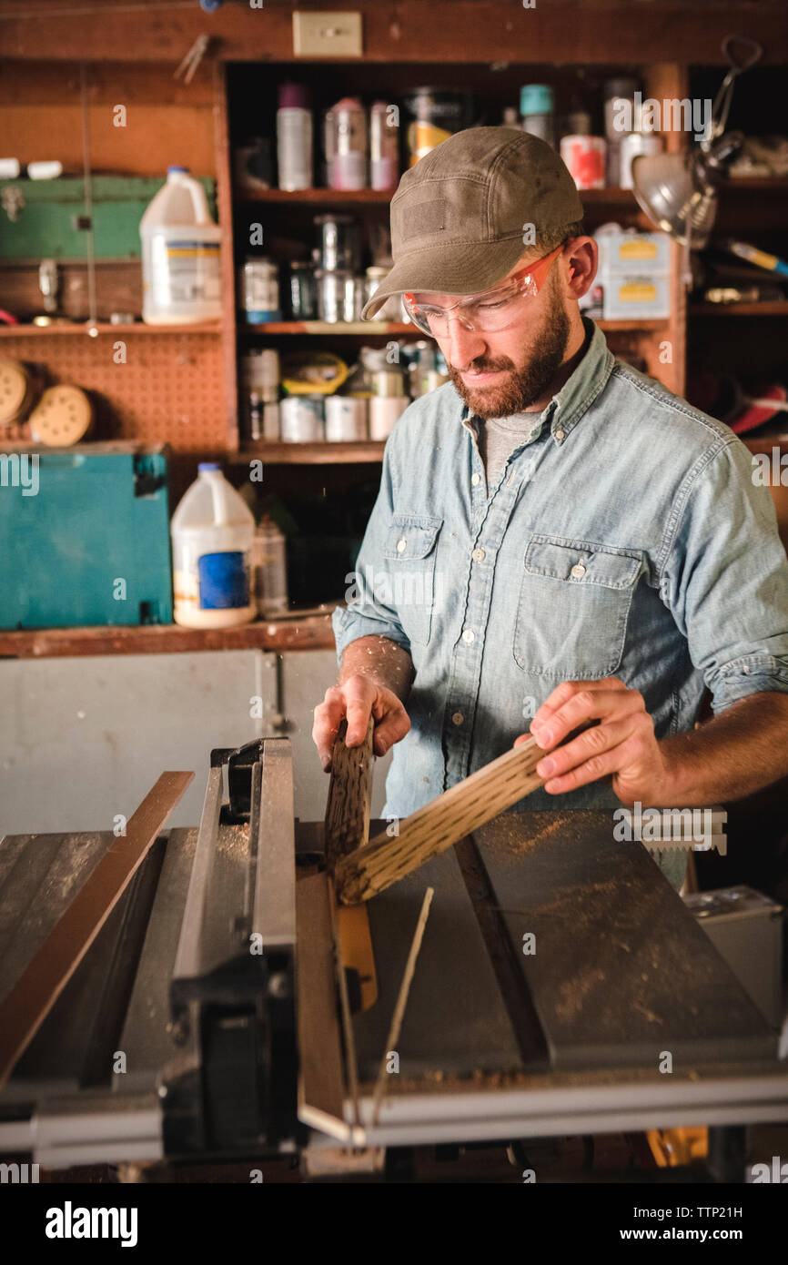 Concentrated craftsperson working at workbench in art studio Stock ...