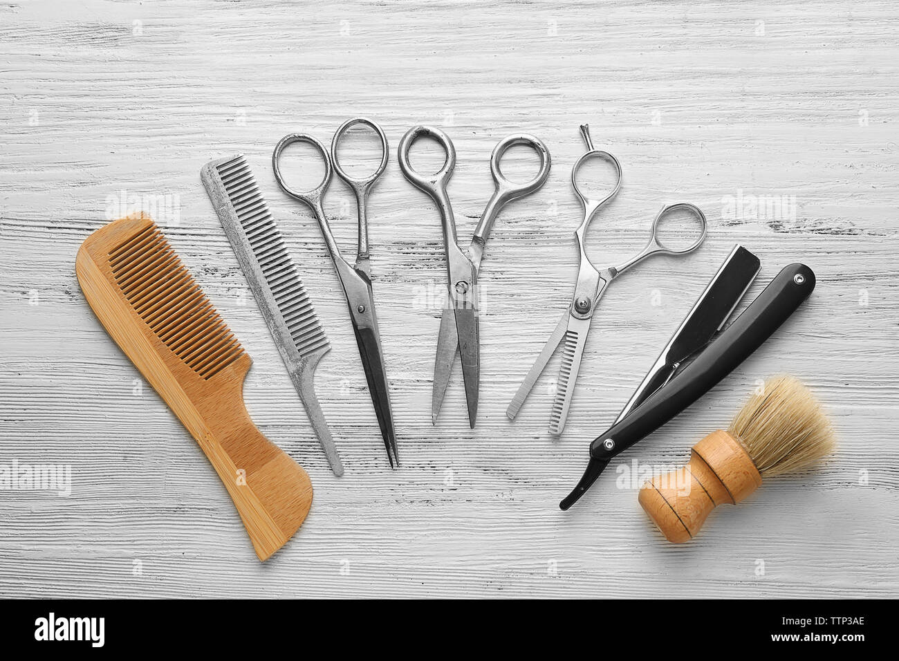 Vintage tools of barber shop on light wooden background Stock Photo - Alamy