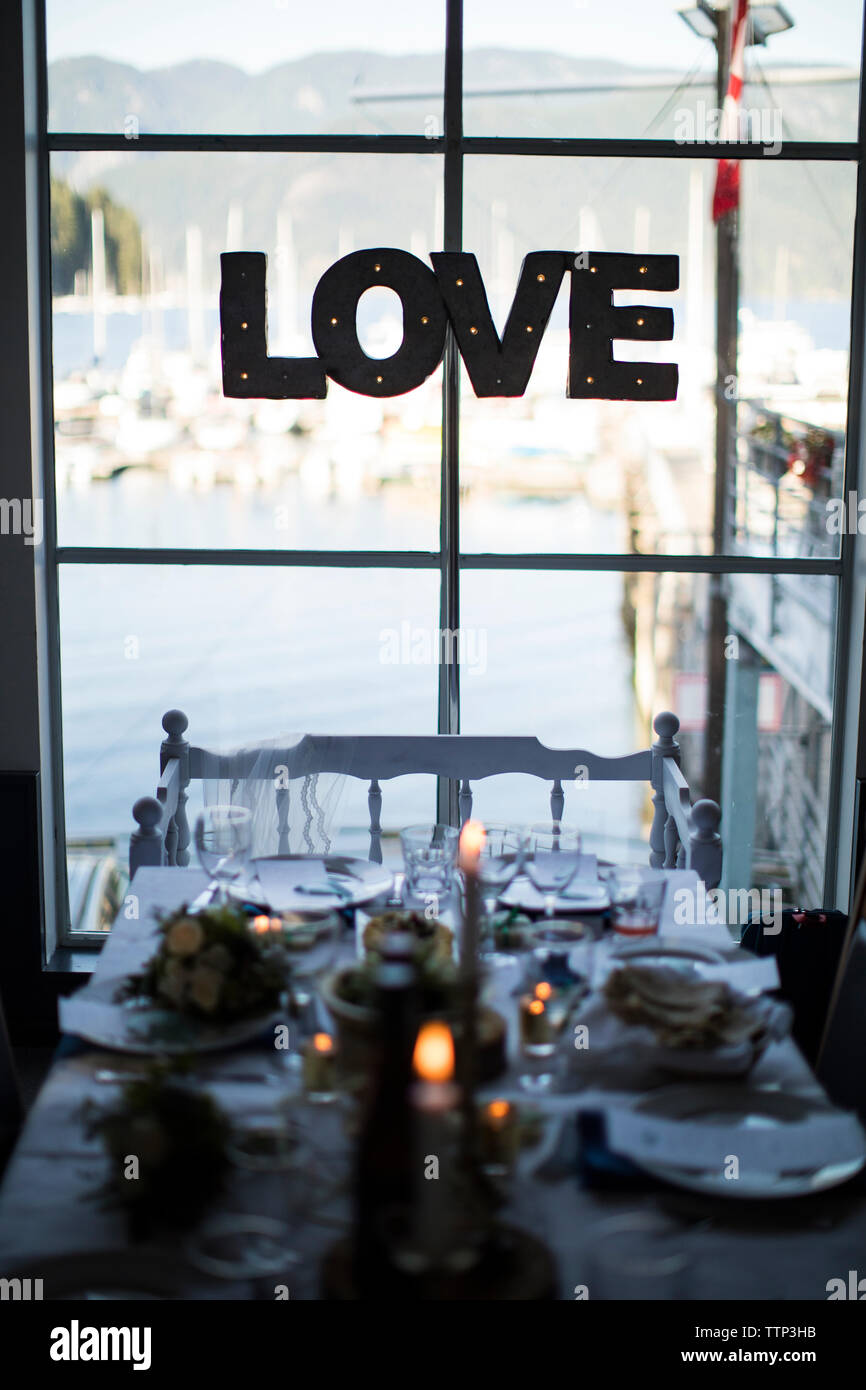 Love text on window in restaurant during wedding ceremony Stock Photo ...