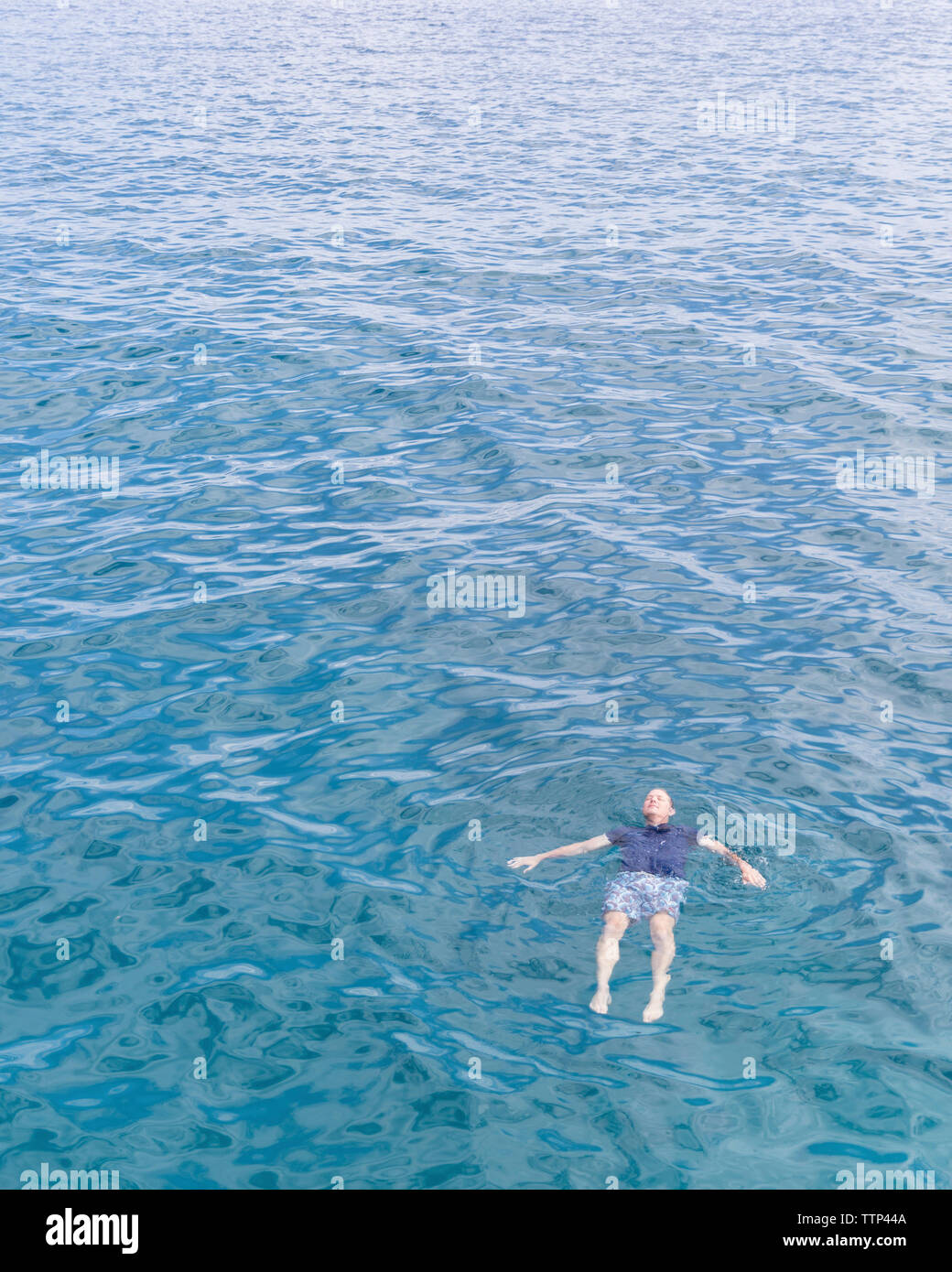 High angle view of man floating in sea Stock Photo - Alamy