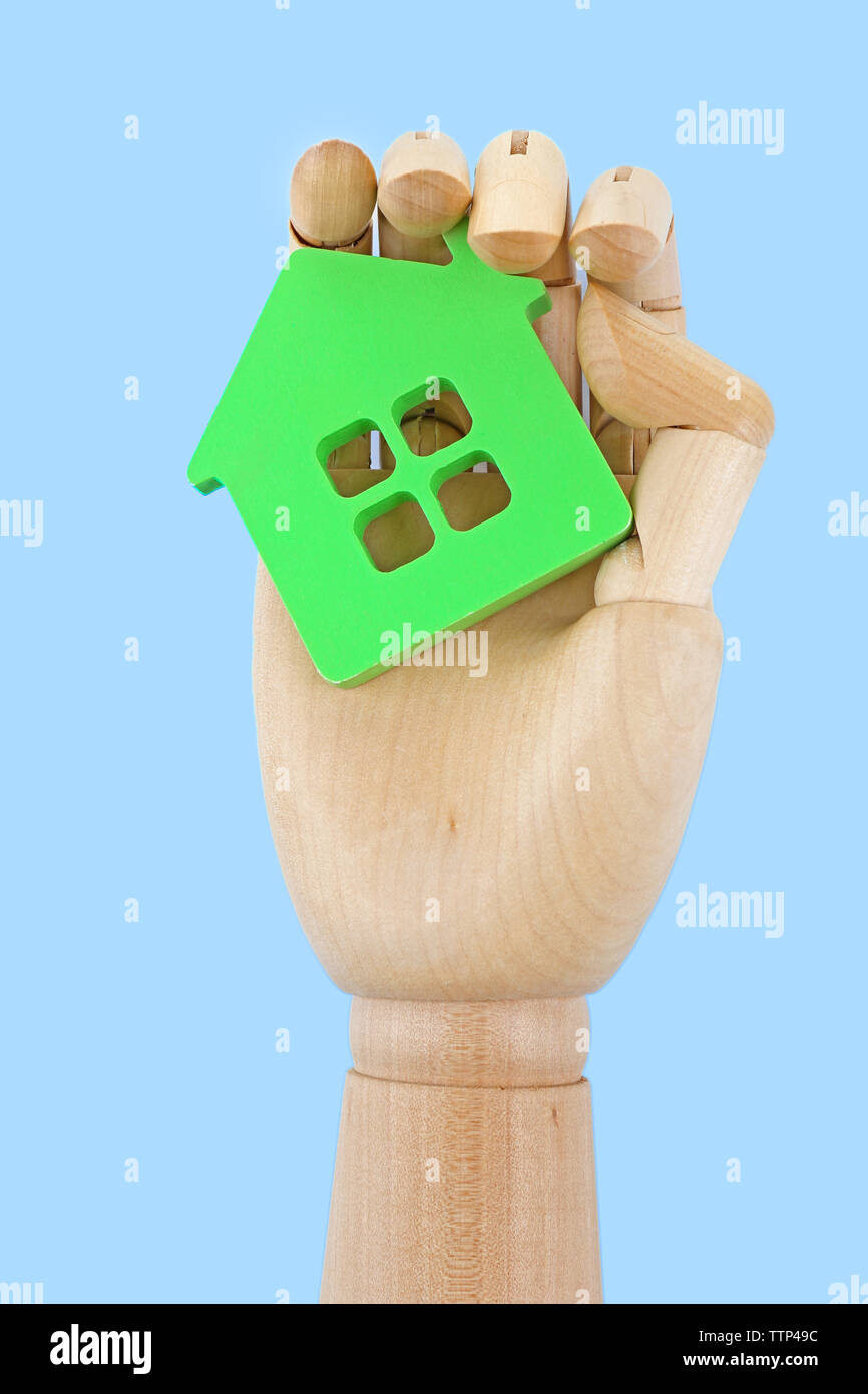 Wooden hand holding model of house on white background Stock Photo - Alamy