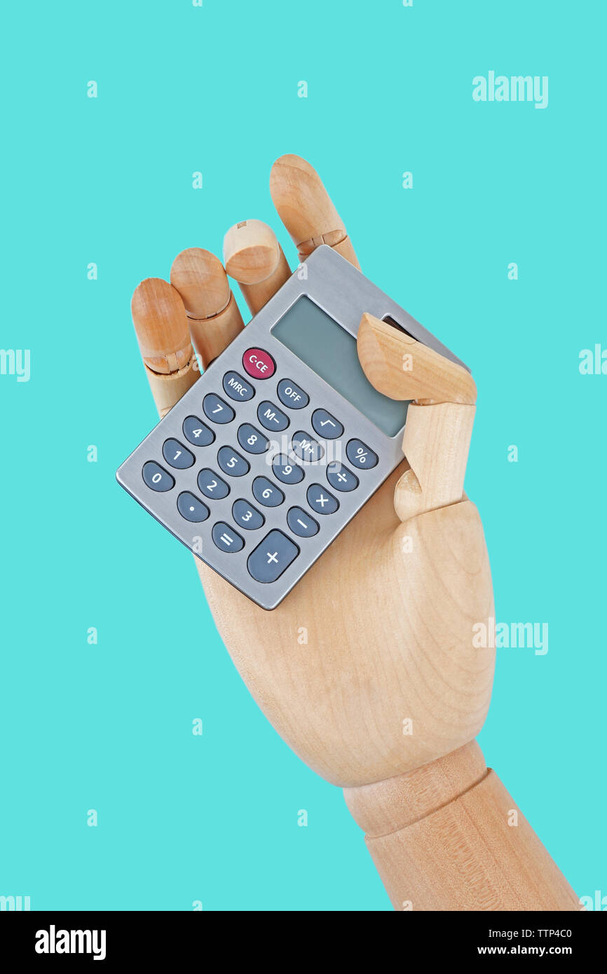 Wooden hand holding calculator on white background Stock Photo - Alamy