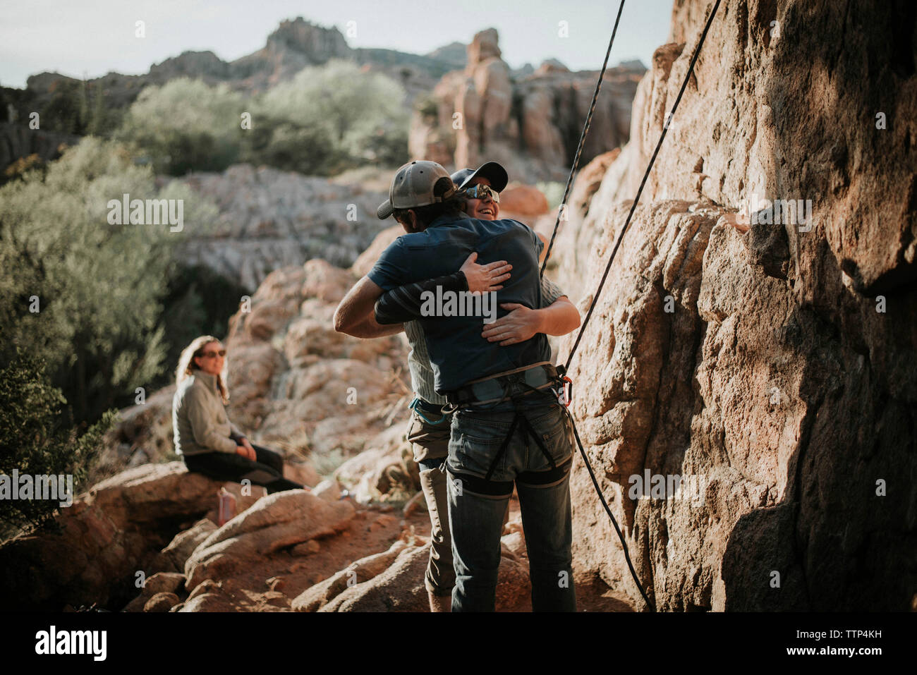 Three men sitting on rock hi-res stock photography and images - Alamy