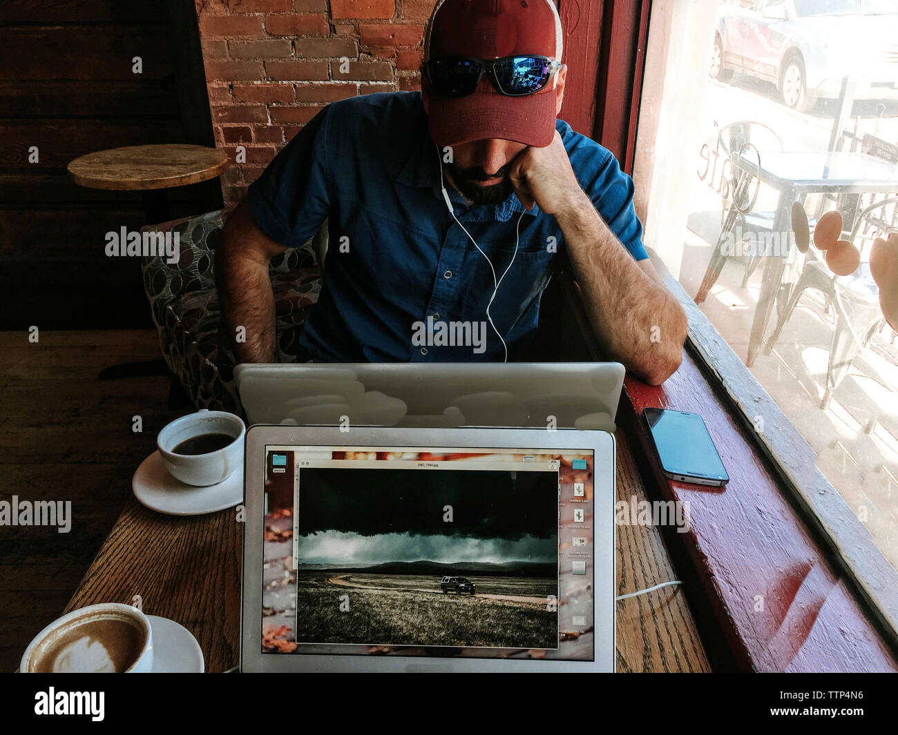 High angle view of man using laptop computer while sitting in cafe ...