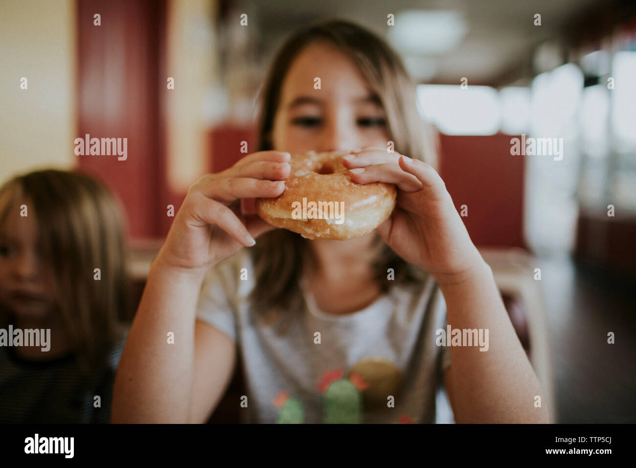 Girl eating donut hi-res stock photography and images - Alamy