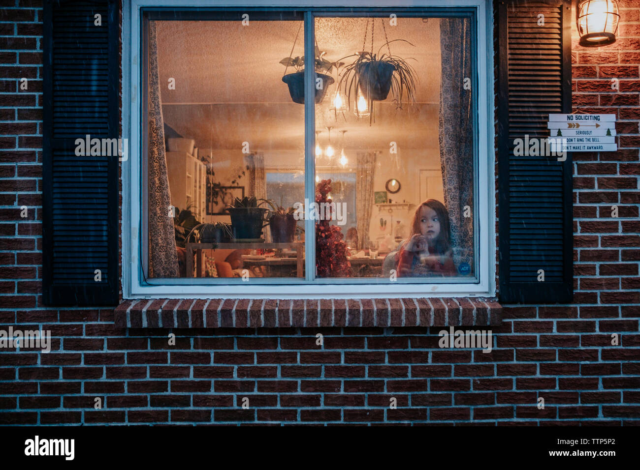Bored little girl, looking out of her window in Colorado Stock Photo ...