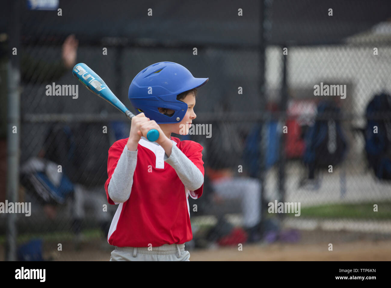 Boy playing baseball at sports field Stock Photo - Alamy