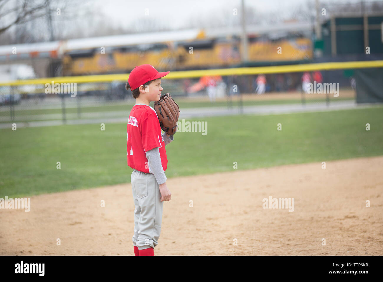 Side view of boy playing baseball at sports field Stock Photo - Alamy