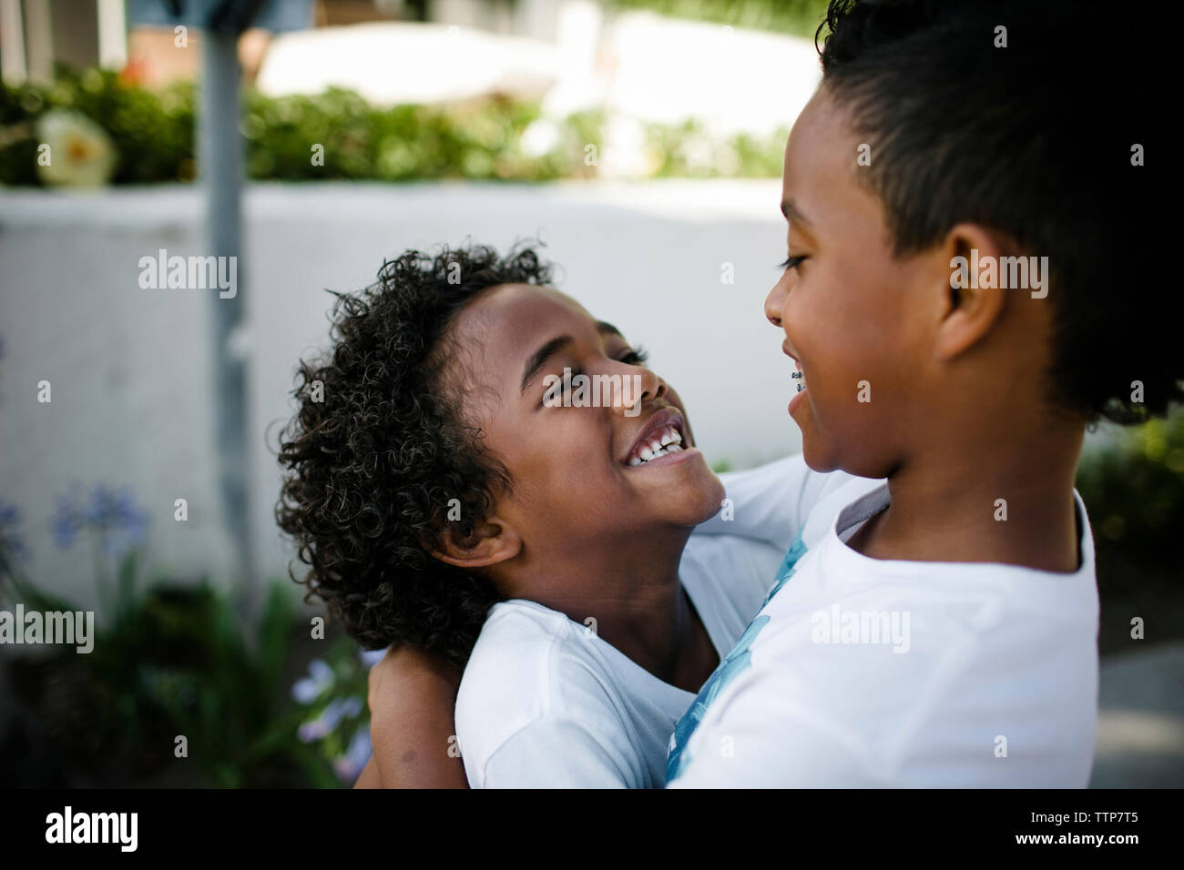 Two siblings standing side in hi-res stock photography and images - Alamy