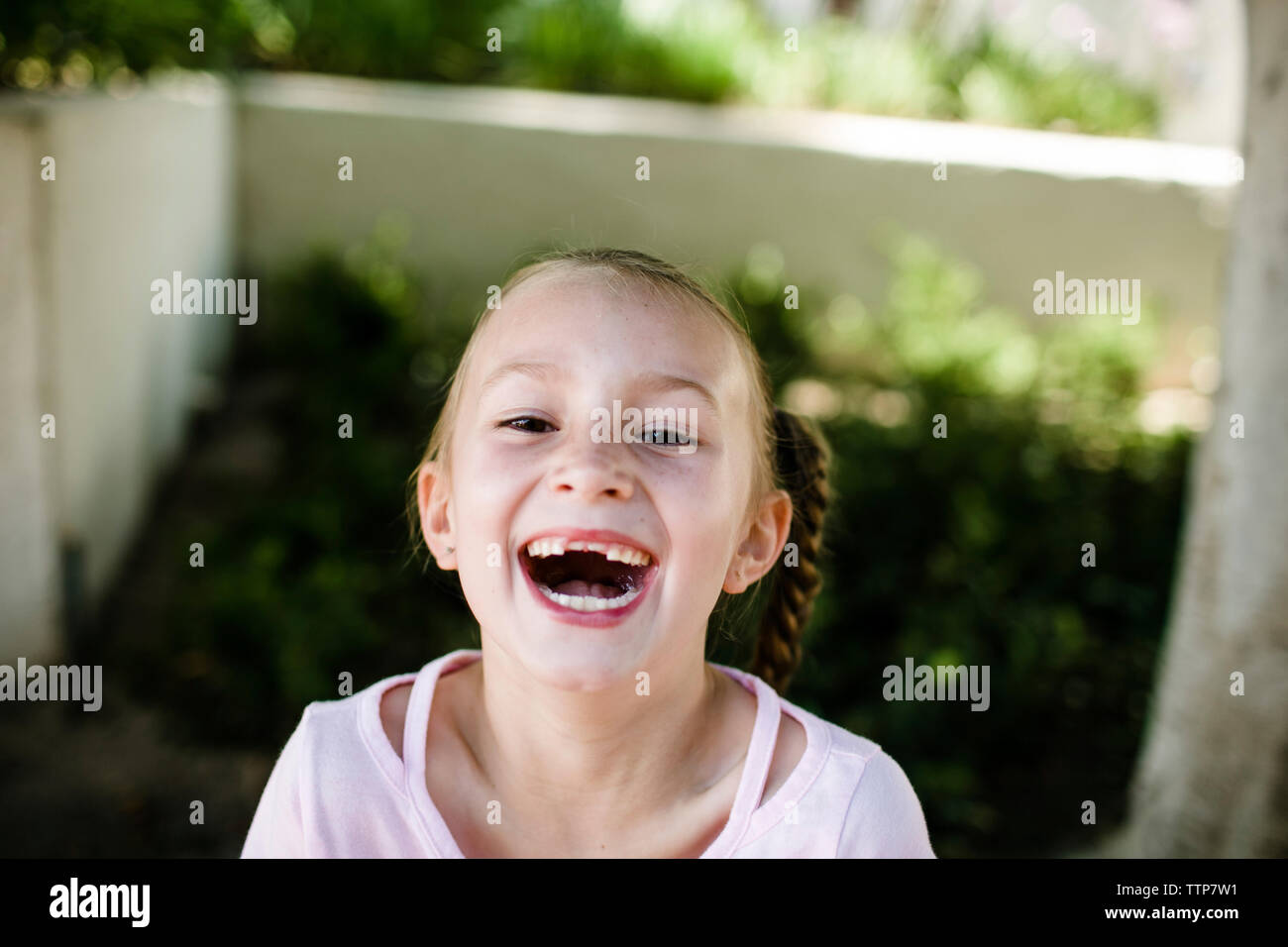 High angle portrait of cute girl laughing at park Stock Photo - Alamy