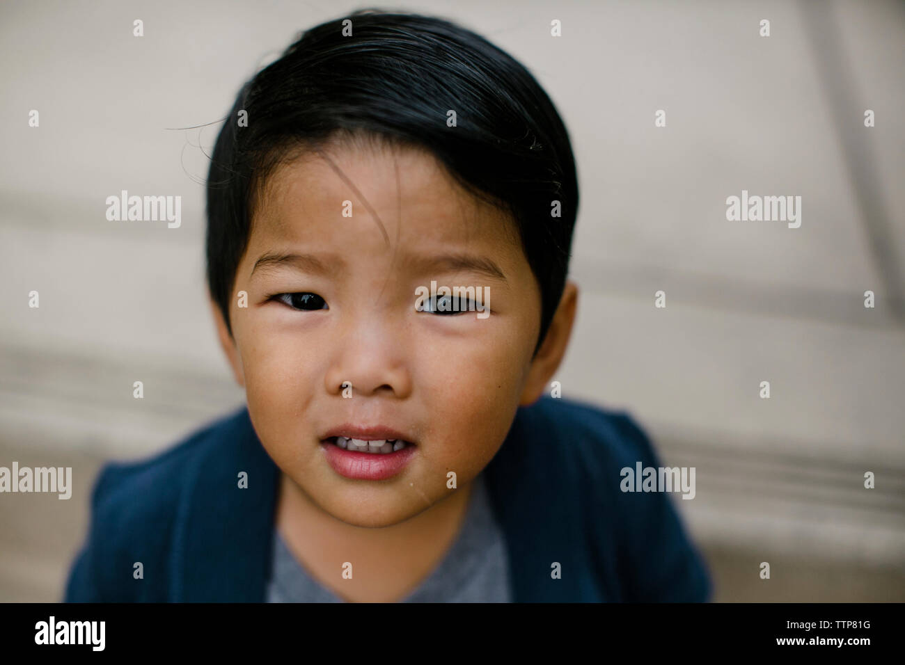 Close-up portrait of cute baby boy sitting on steps in Balboa Park ...