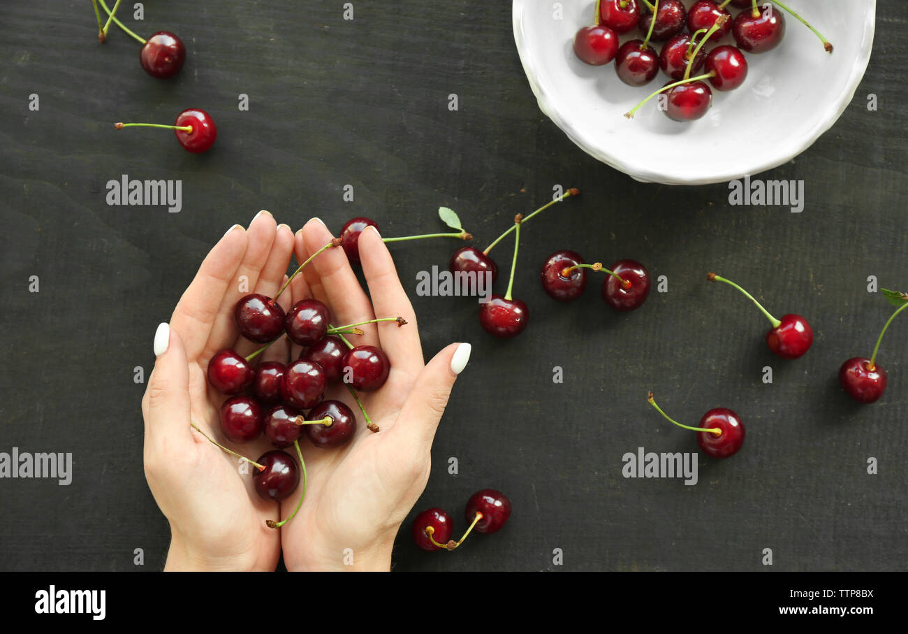 Human hands holding cherries, top view Stock Photo - Alamy