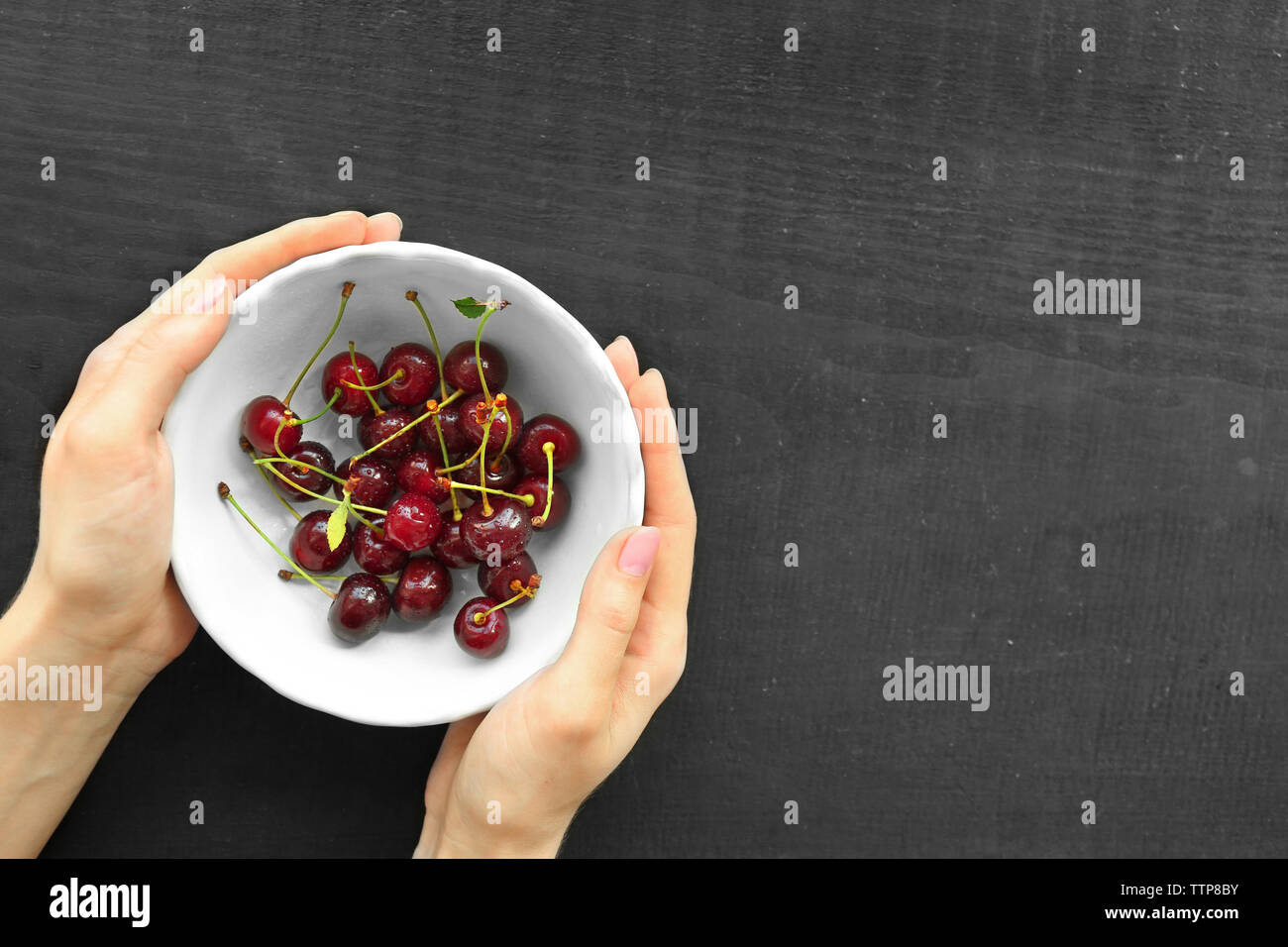 Human hands holding cherries, top view Stock Photo - Alamy