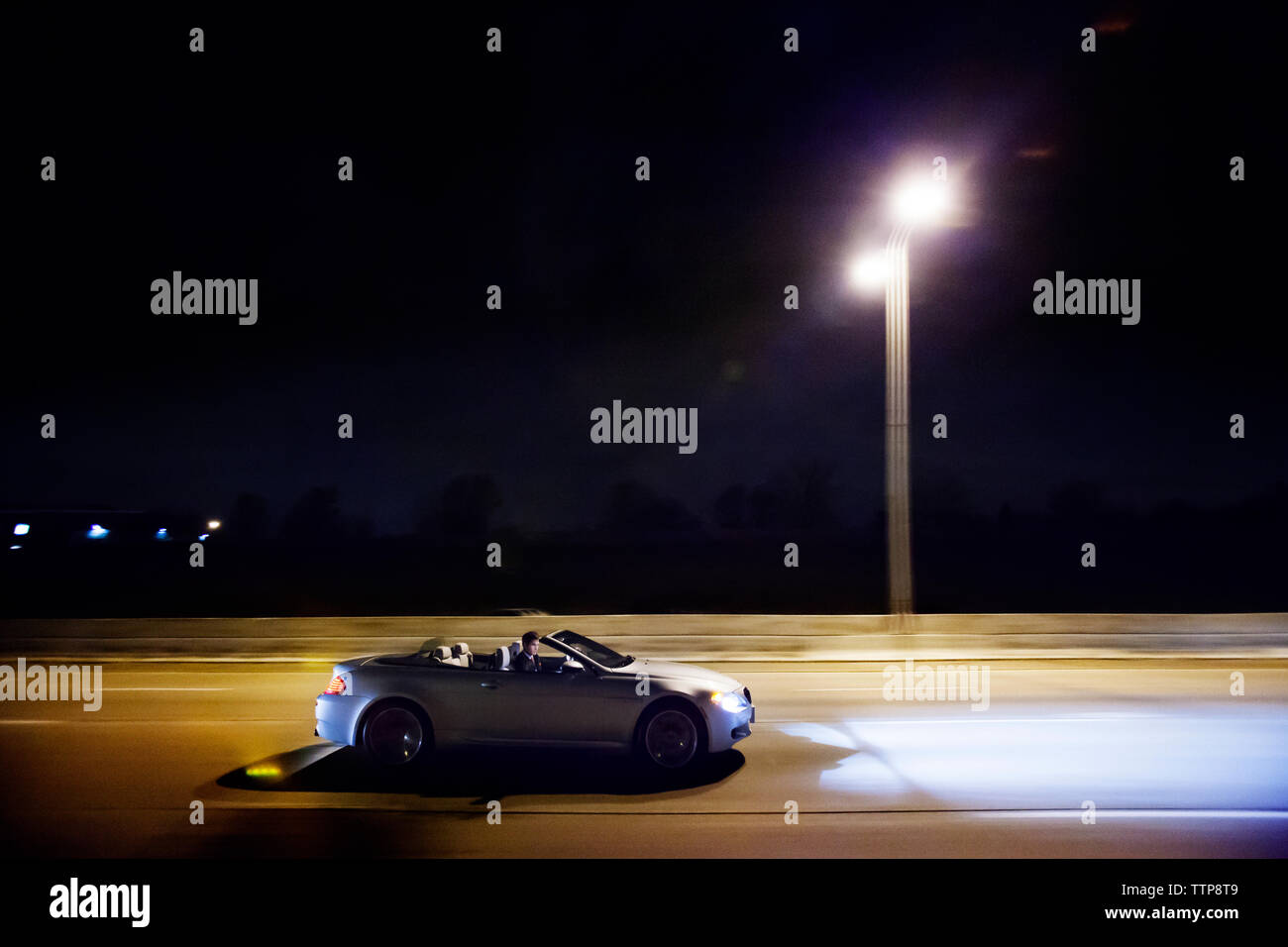 Man driving car on illuminated bridge against clear sky at night Stock ...