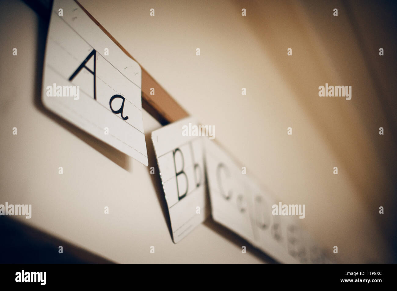 Low angle view of alphabets written on paper hanging in classroom Stock ...